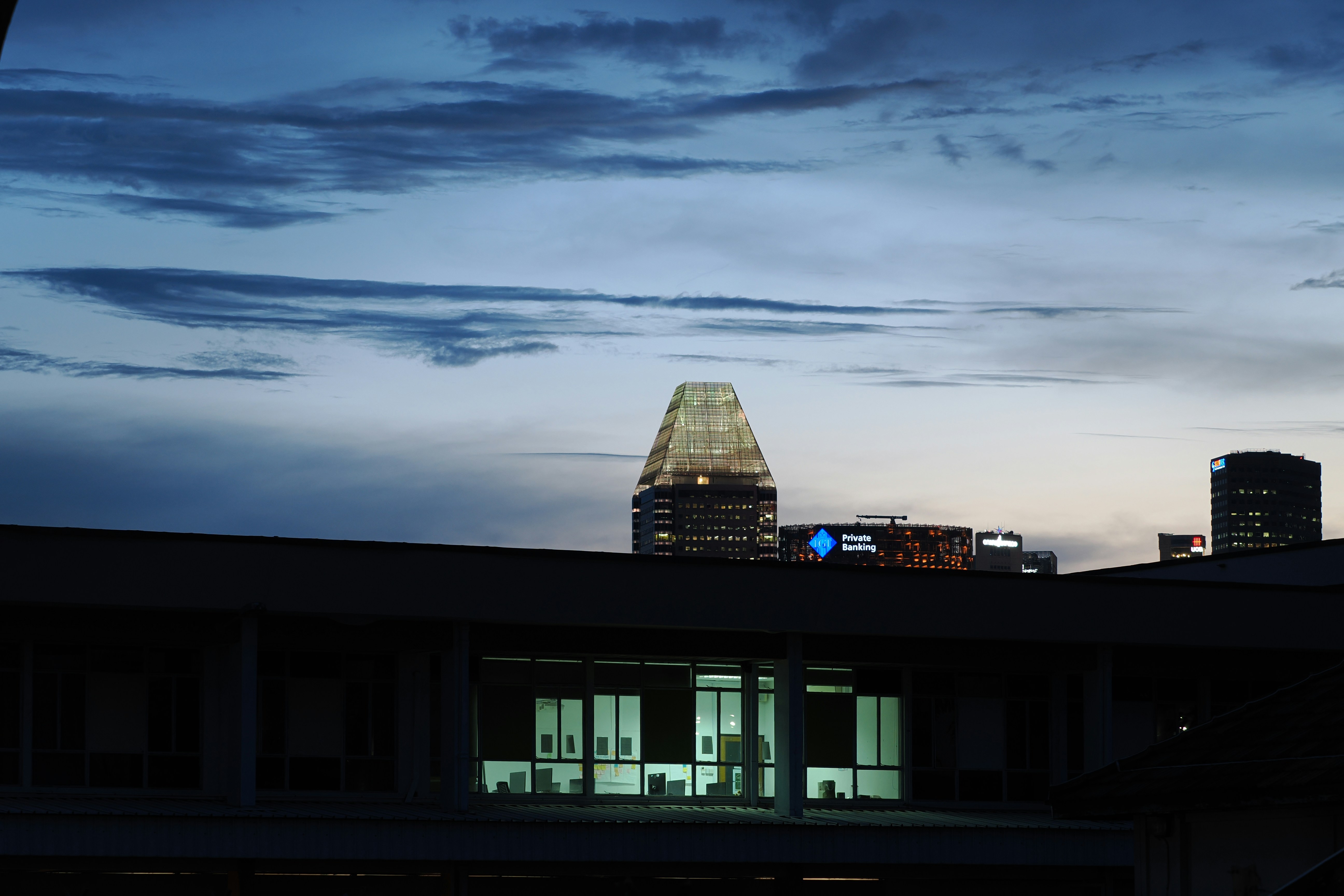 Glassed Office at Dusk: A City Skyline's Quiet Portal