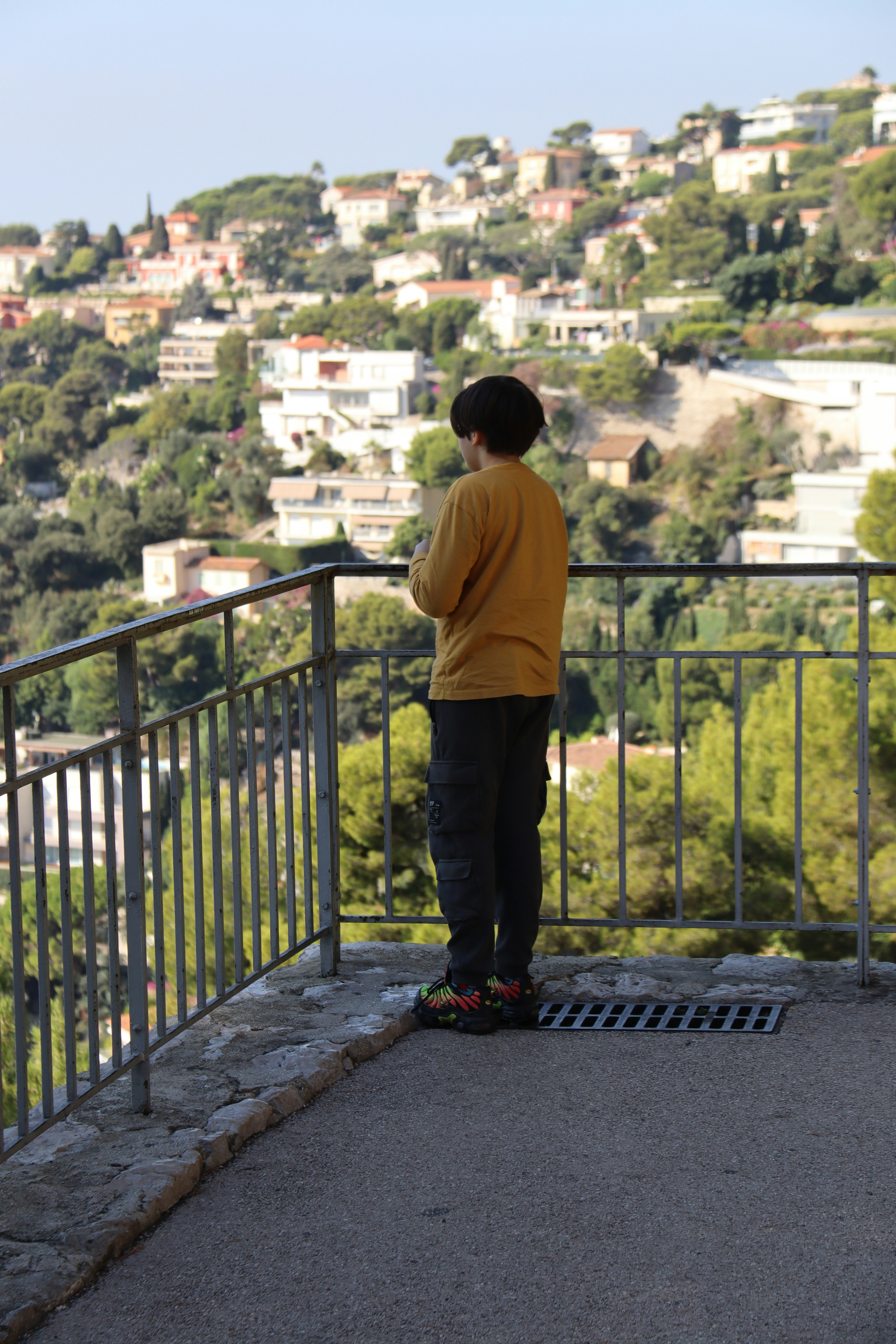 On the Cliff's Edge: A Quiet Moment with Distant Homes