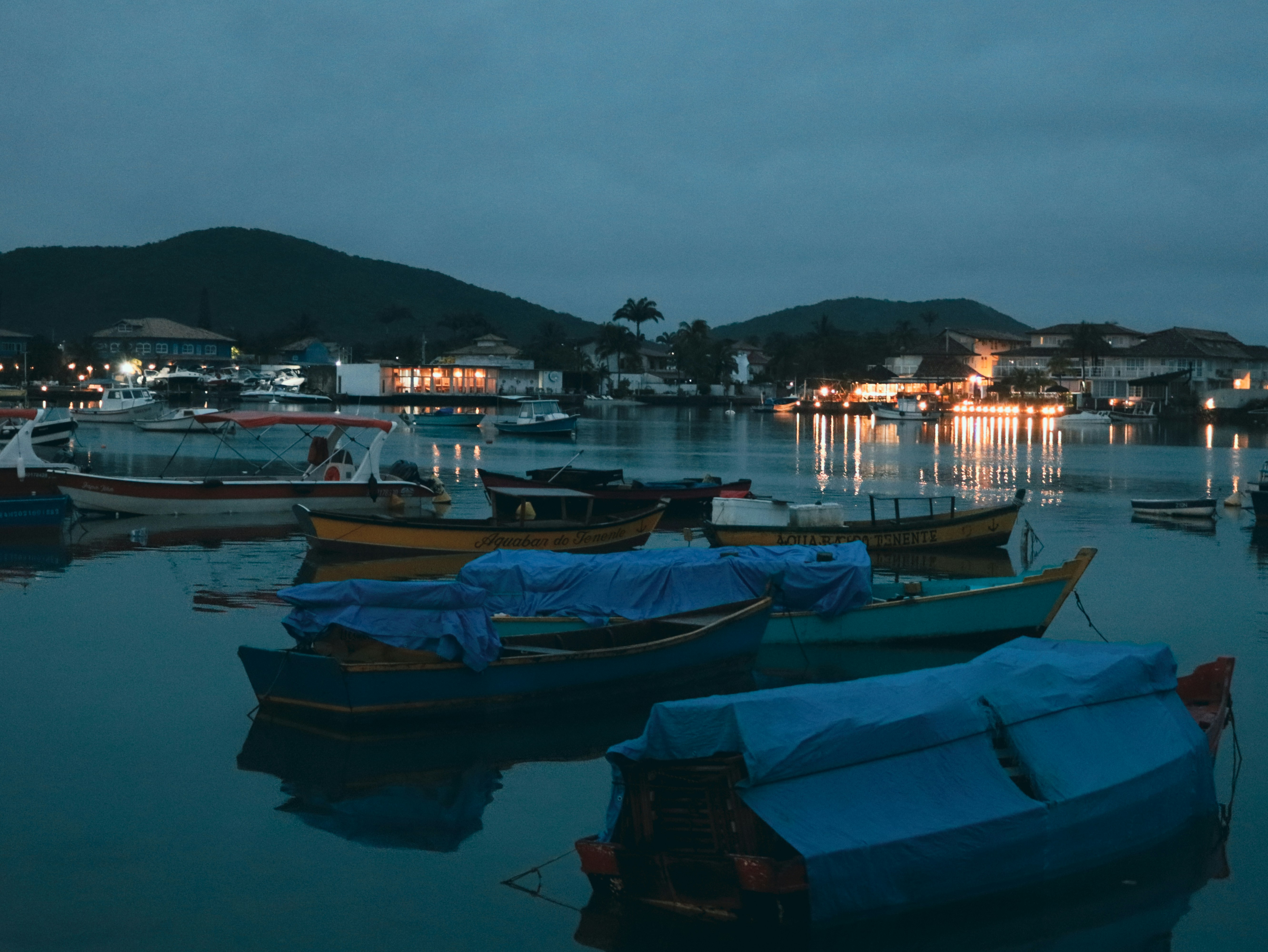 Moonlit Harbor: Boats Rest in Quiet Reflections