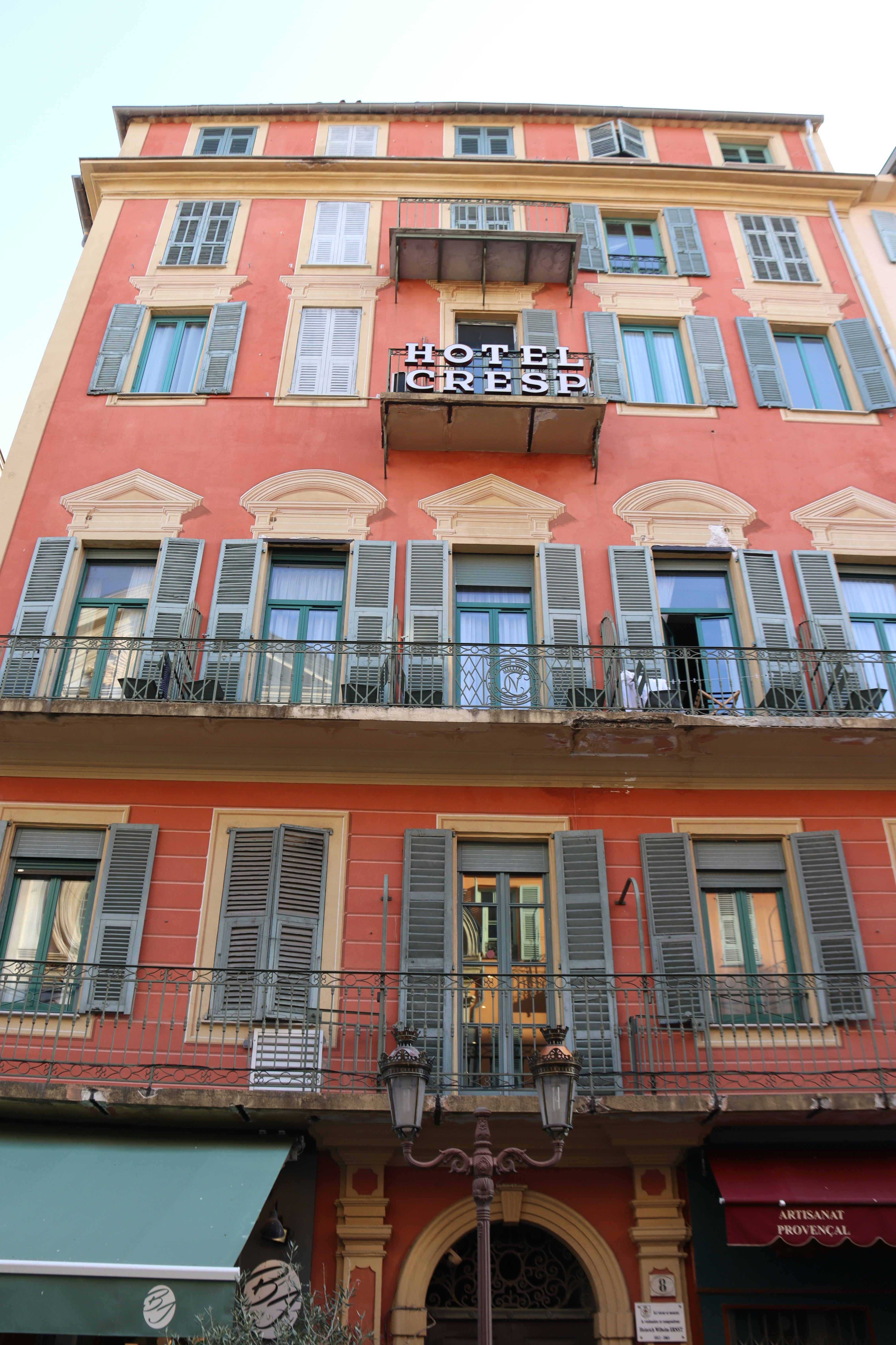 Hotel Crest in Coral Facade with Shuttered Windows and Balcony Detail