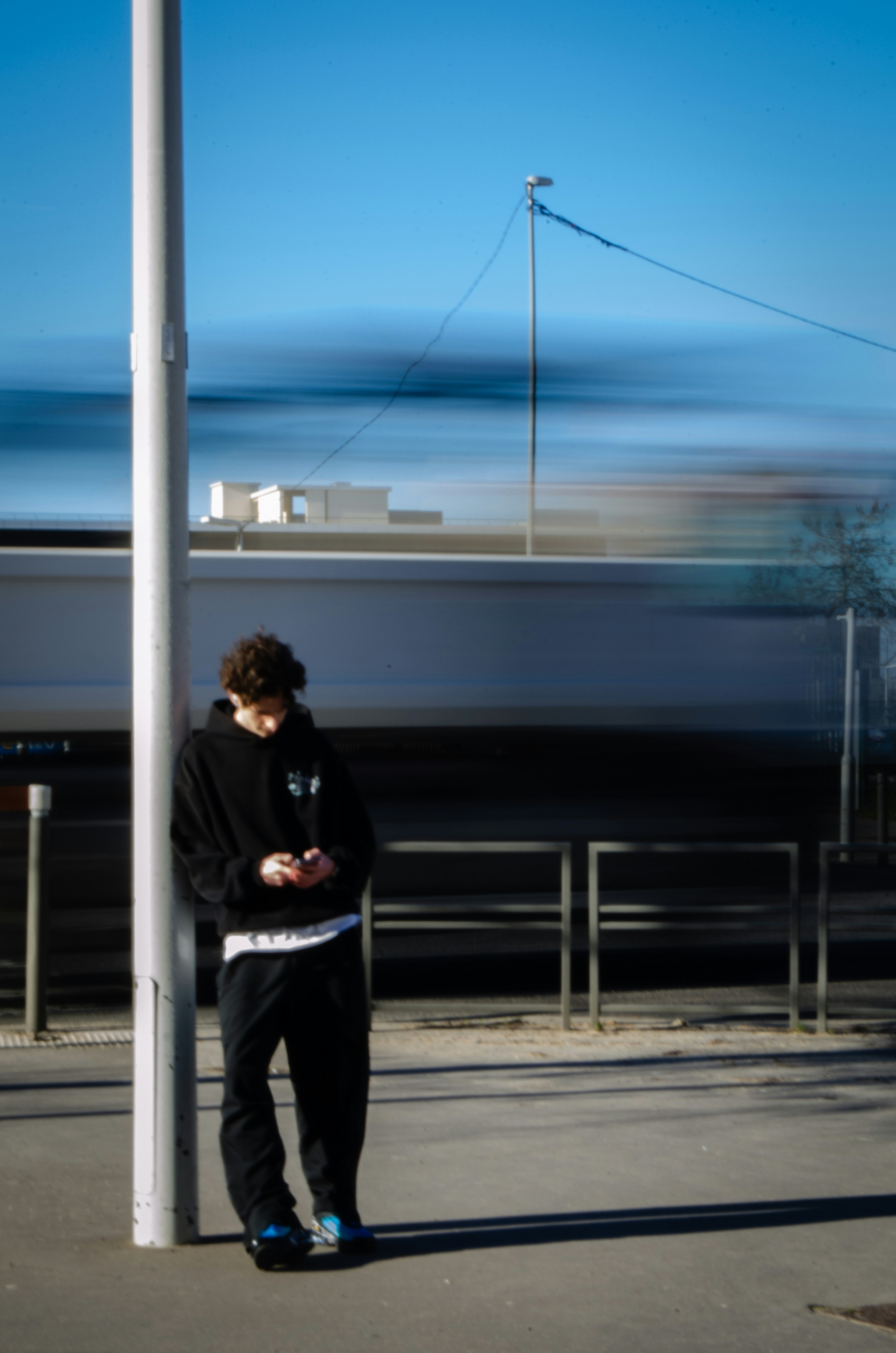Lonely Youth at the Station: A Blur of Movement and Quiet Shadow
