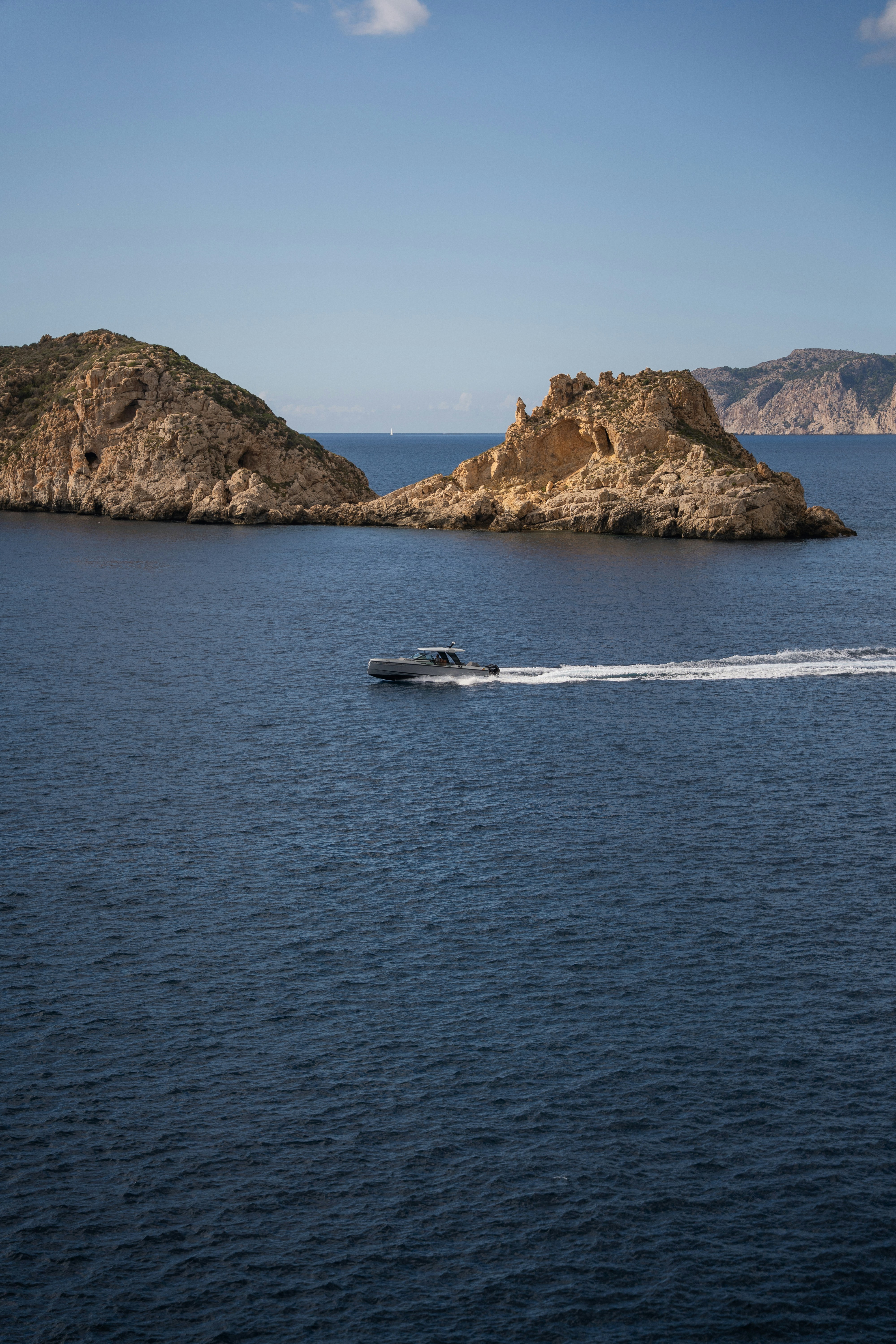 Foam of a Coastal Cruise past Rugged Islands