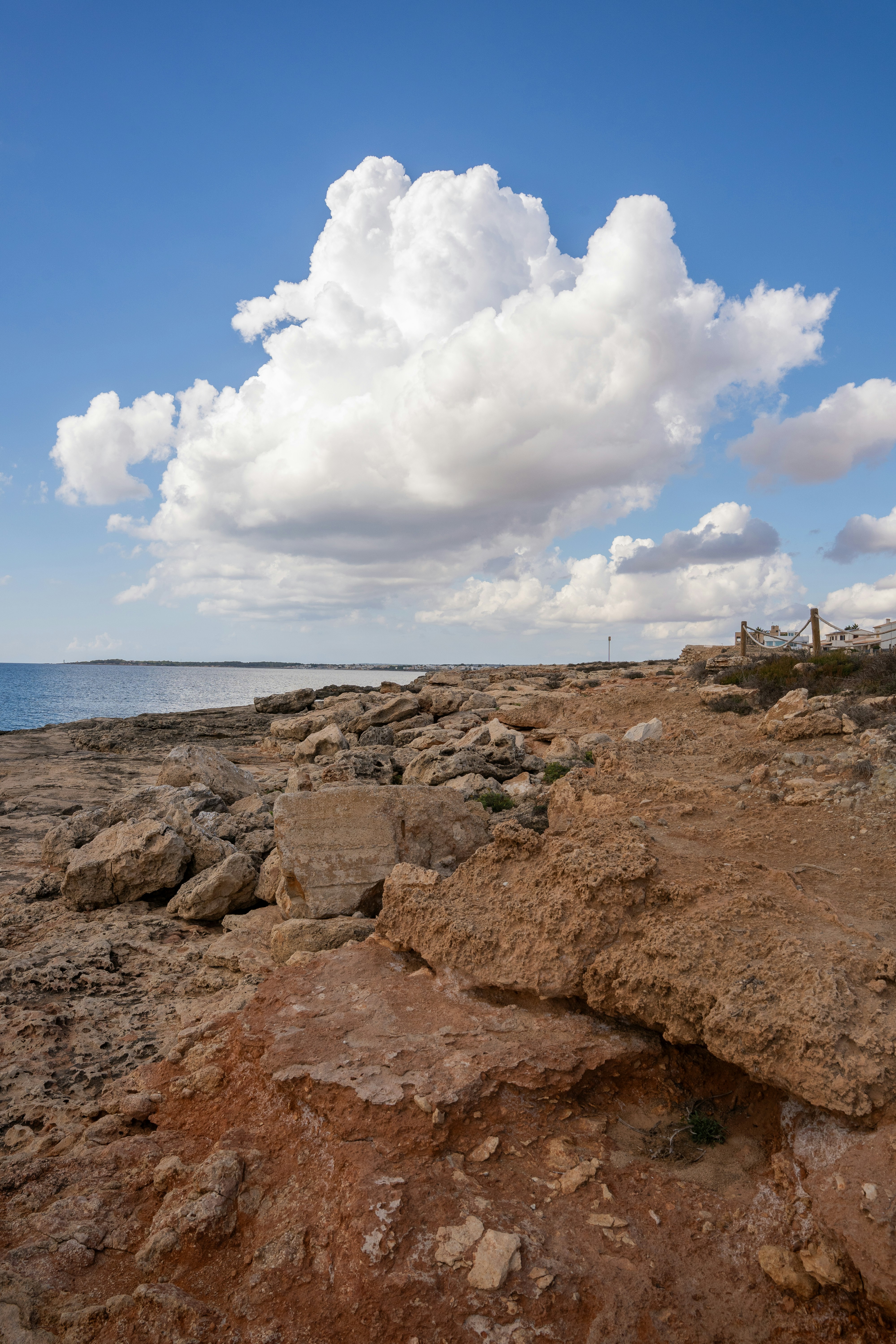 Coastal Ridge Under a Puffy Sea-Blue Sky