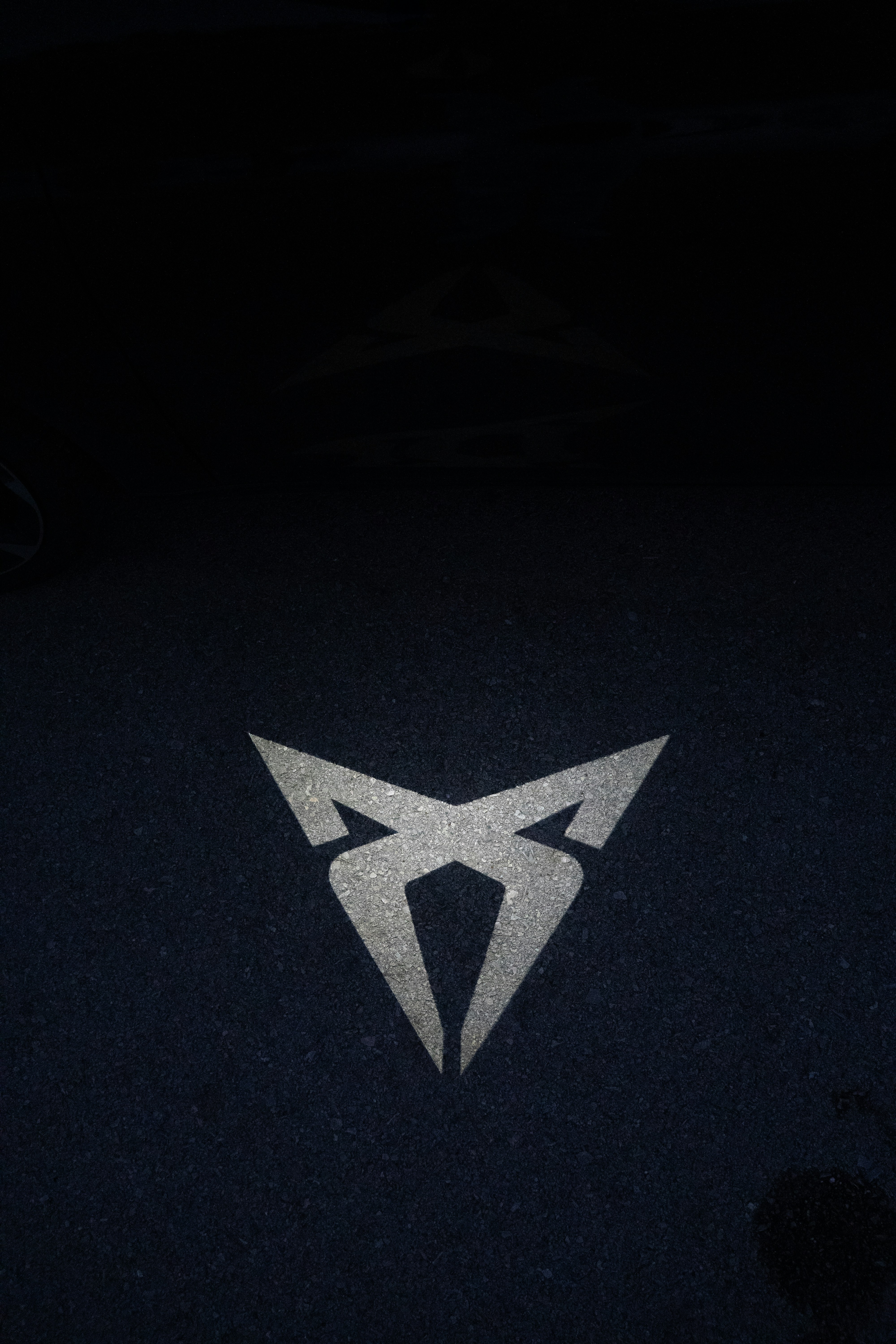 Misplaced Mark: A bold Symbol on Dim Asphalt