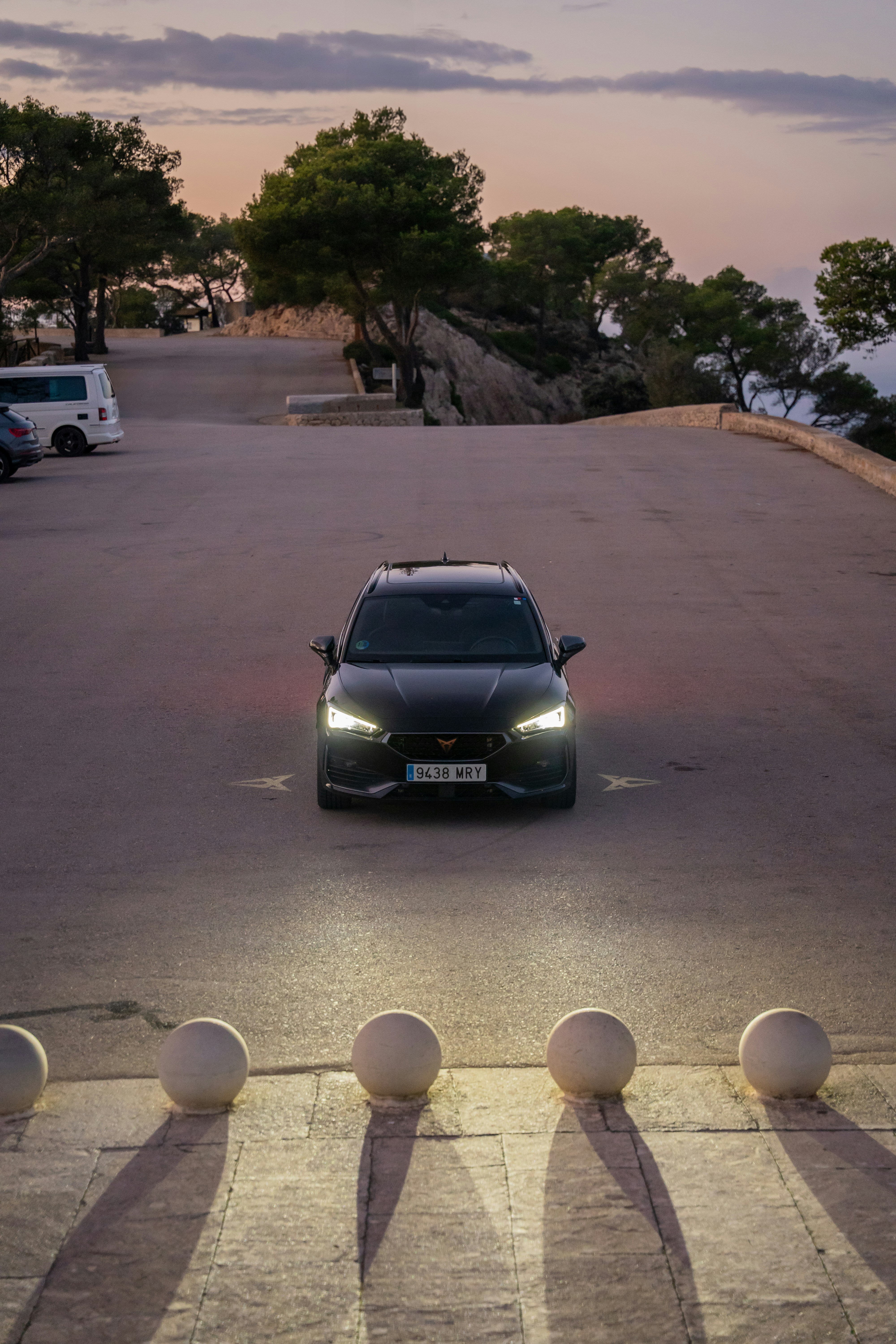Mid‑Drive Sunset: A Dark Hatchback Aligns with Horizon