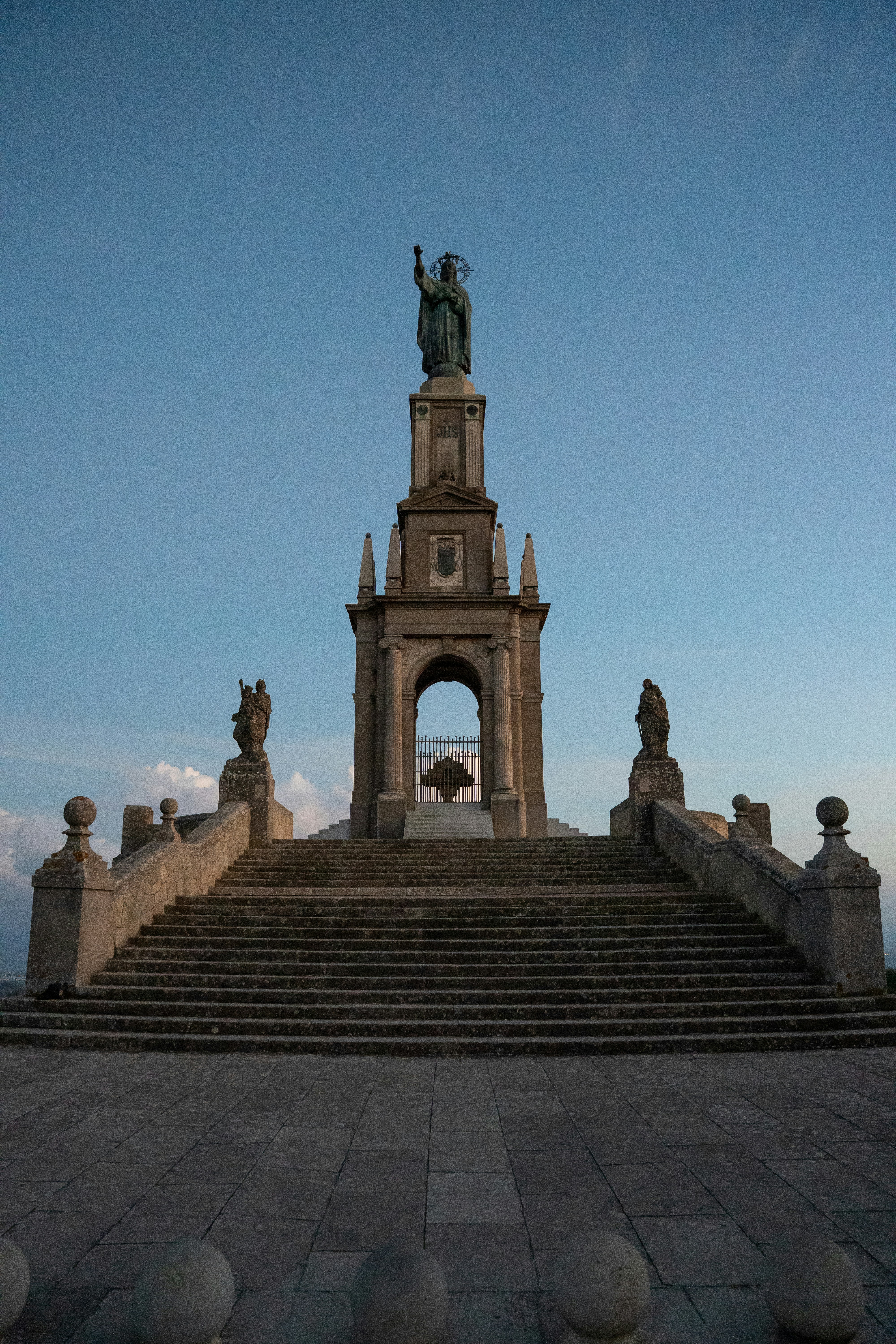 Stairway to the Sentinel: A statueed triumph atop a stone pedestal