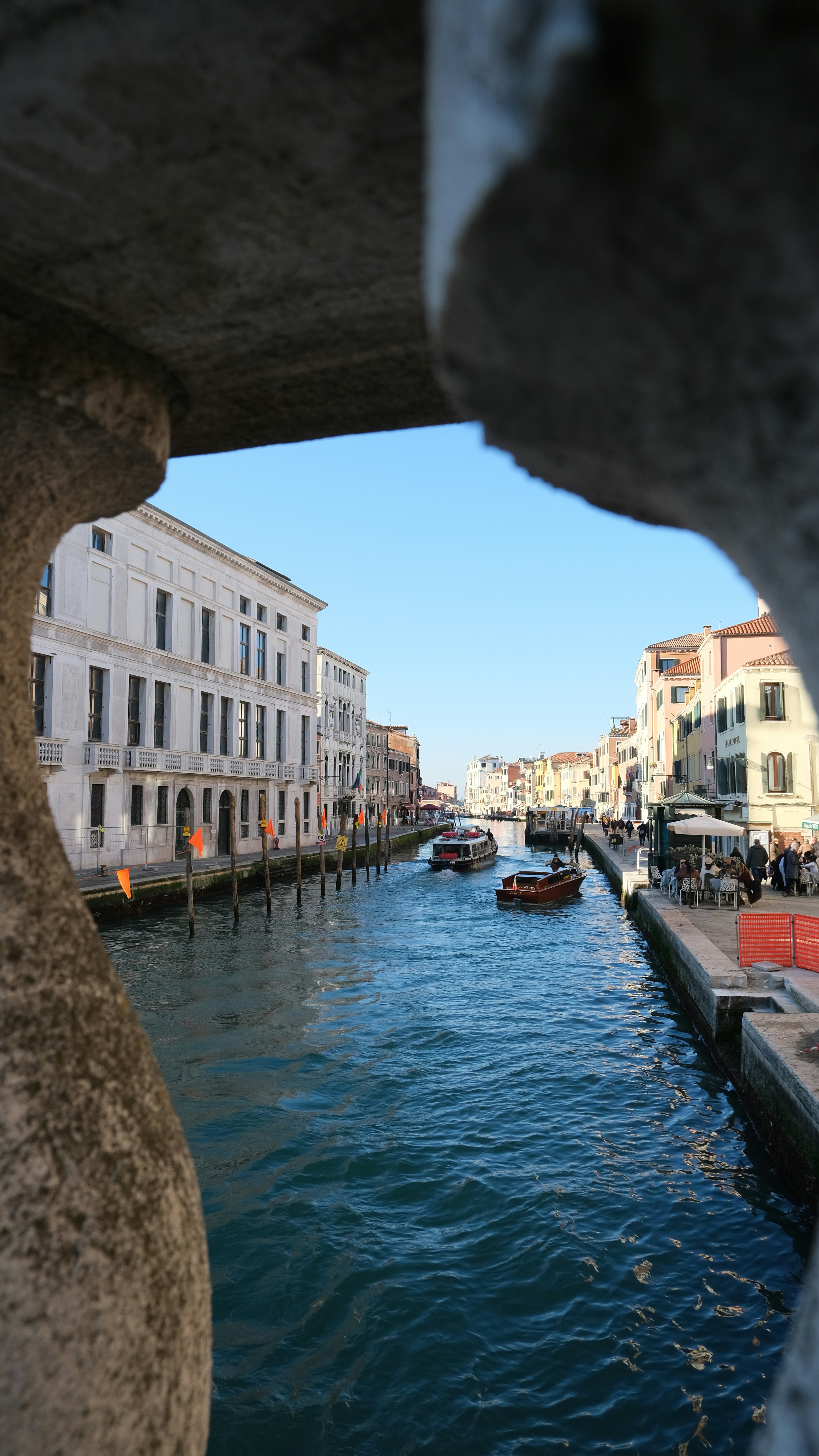 Curtain of Architecture: Canal Frame Through a Stone Arch