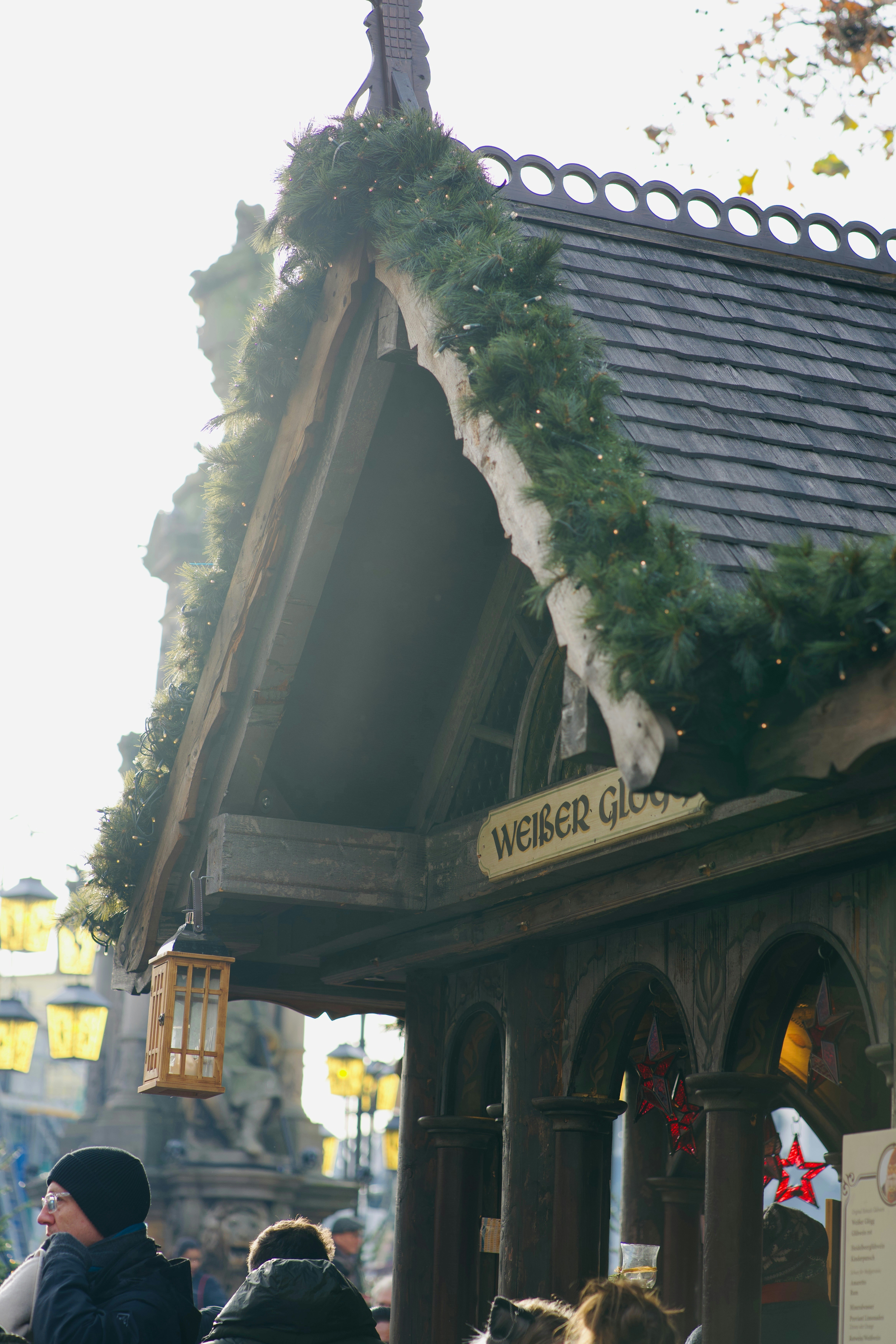 Festive Timbered Facade Adorned with Greenery and Warm Lantern Light