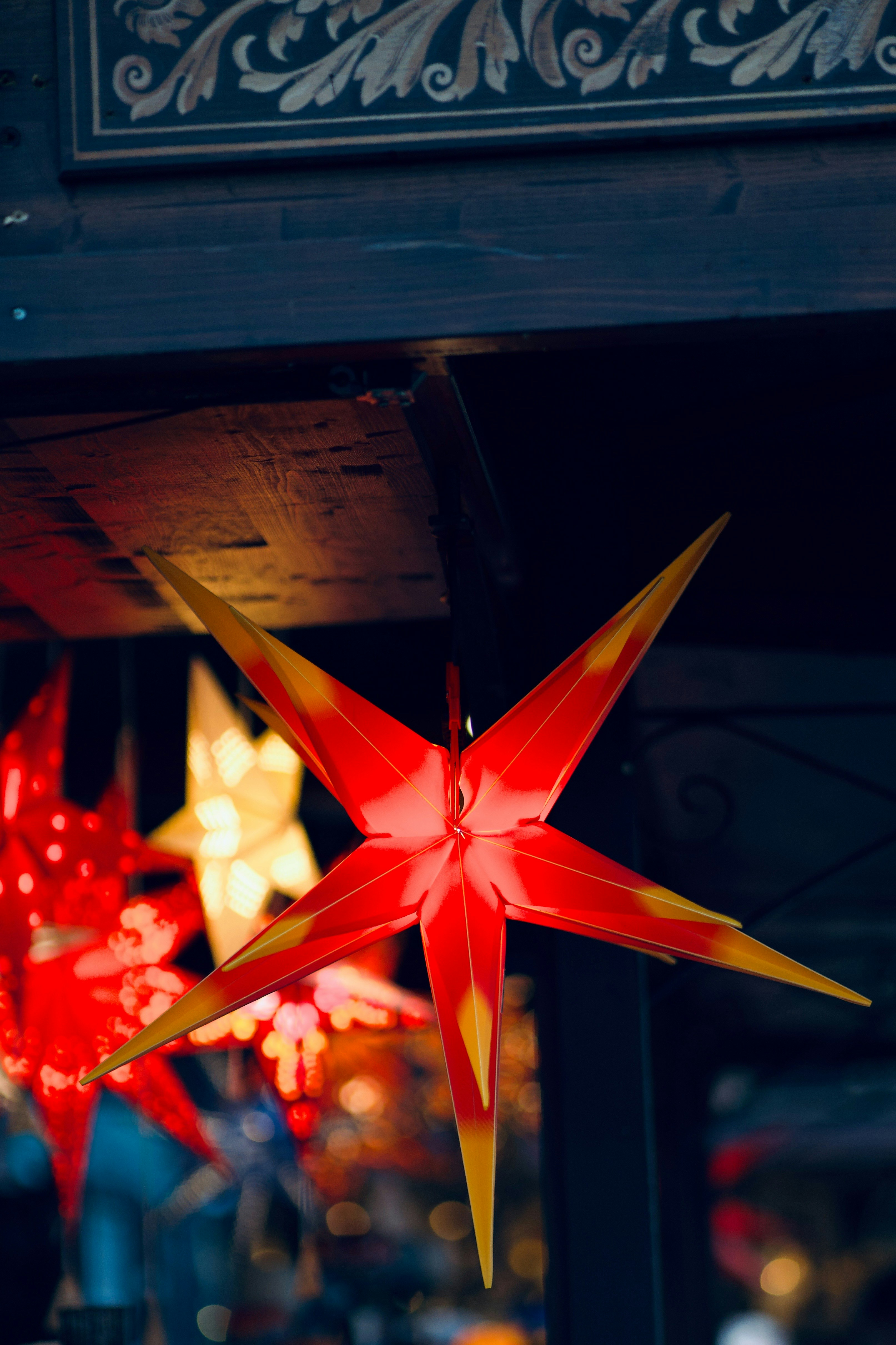 Floating Star: a crimson lantern centerpiece in a dim shop window