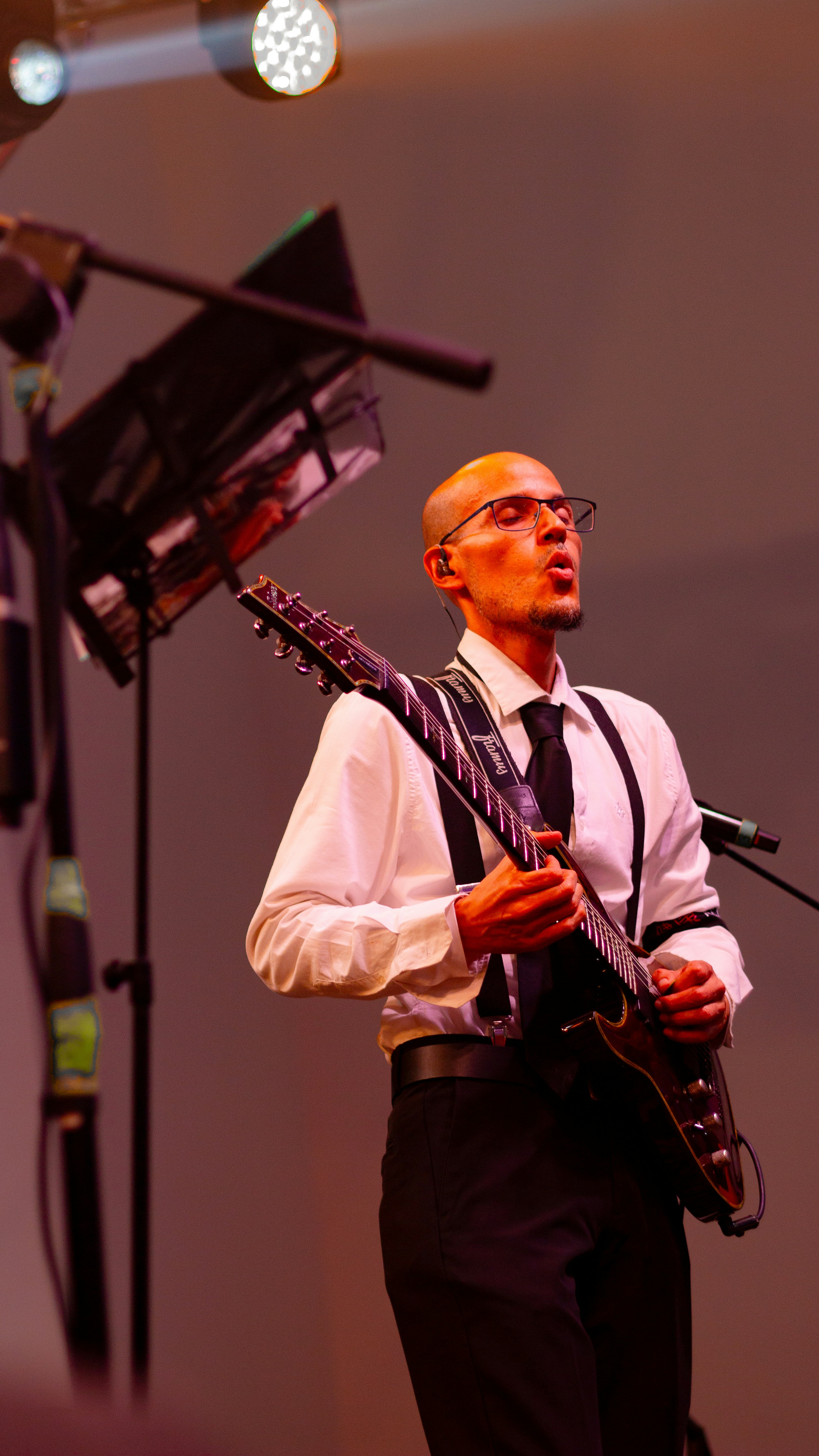 Guitarist Under Stage Lights: Focused Intensity