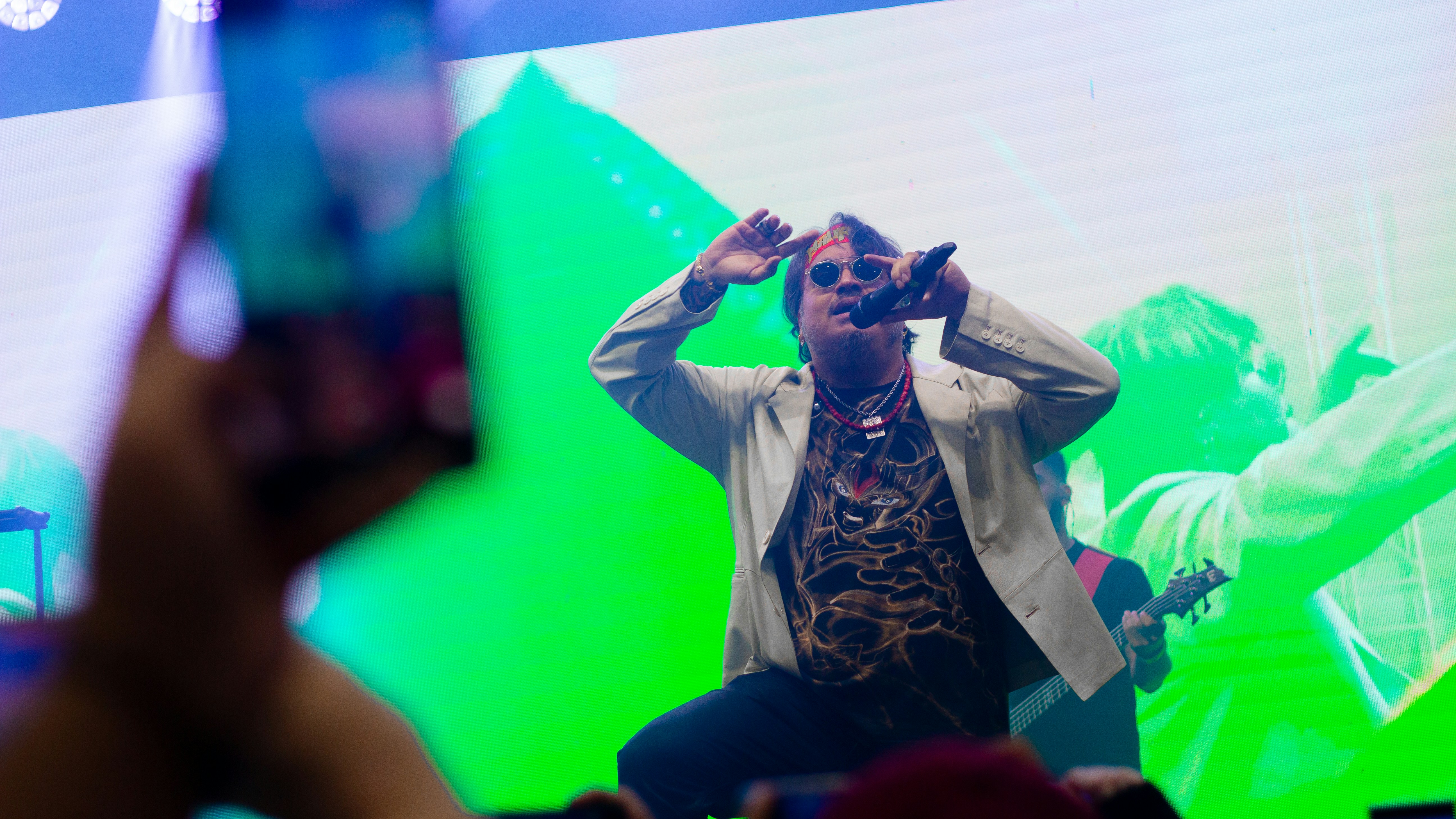 Energetic Frontman under Neon Green Scrim