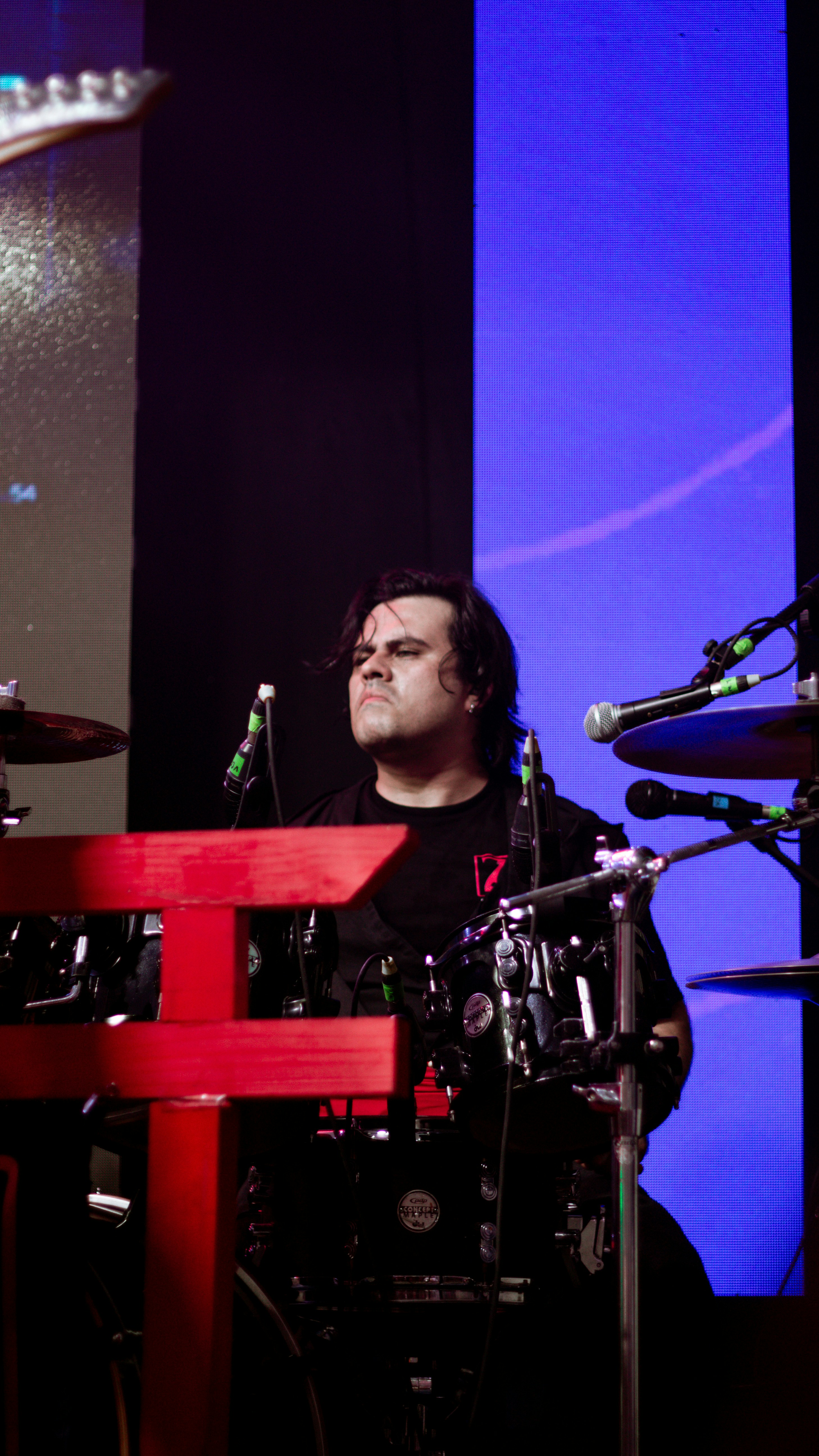Midnight Pulse: Drummer Anchored by a Neon Stage