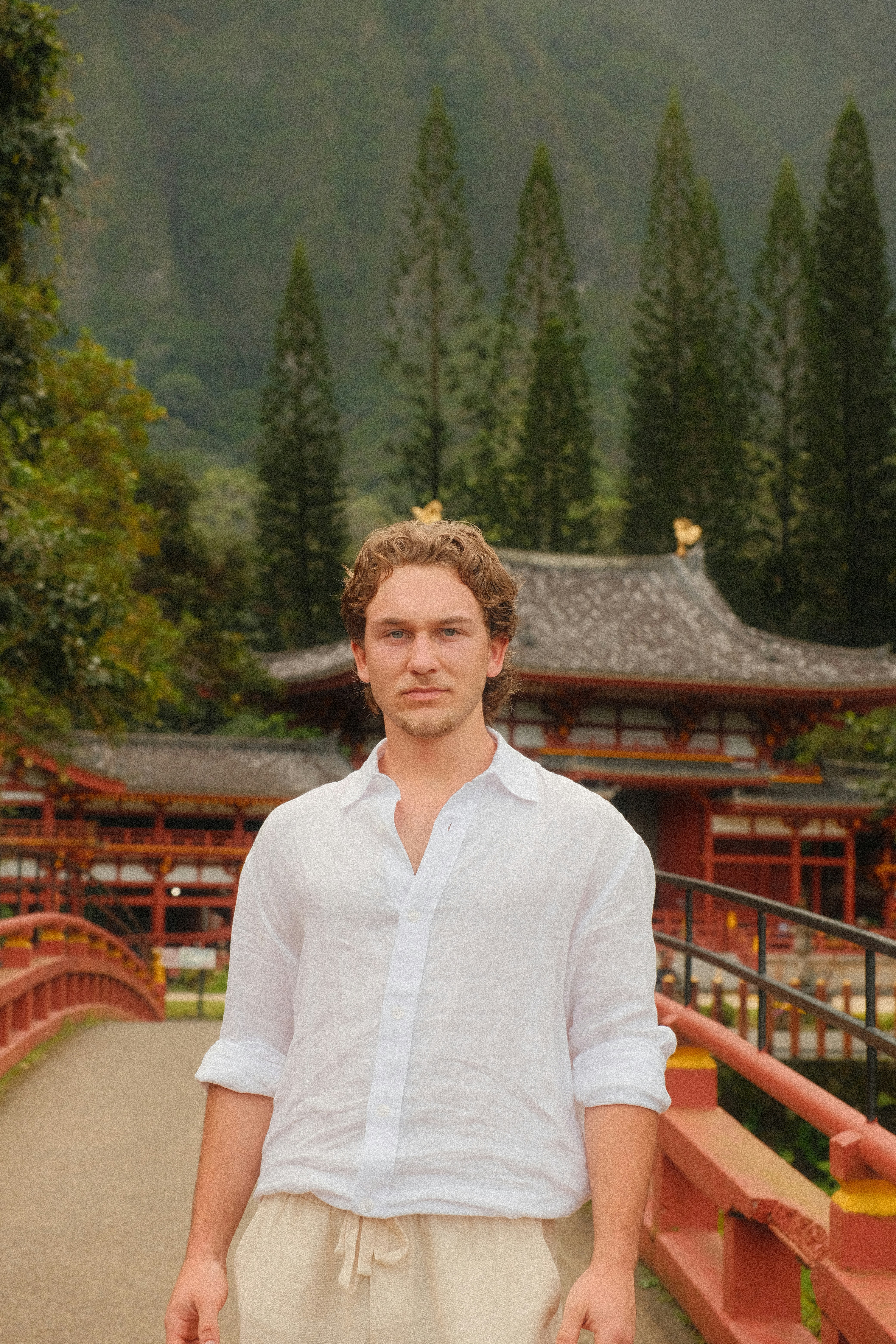 Casual Traveler in a Red-Bridged Japanese Garden