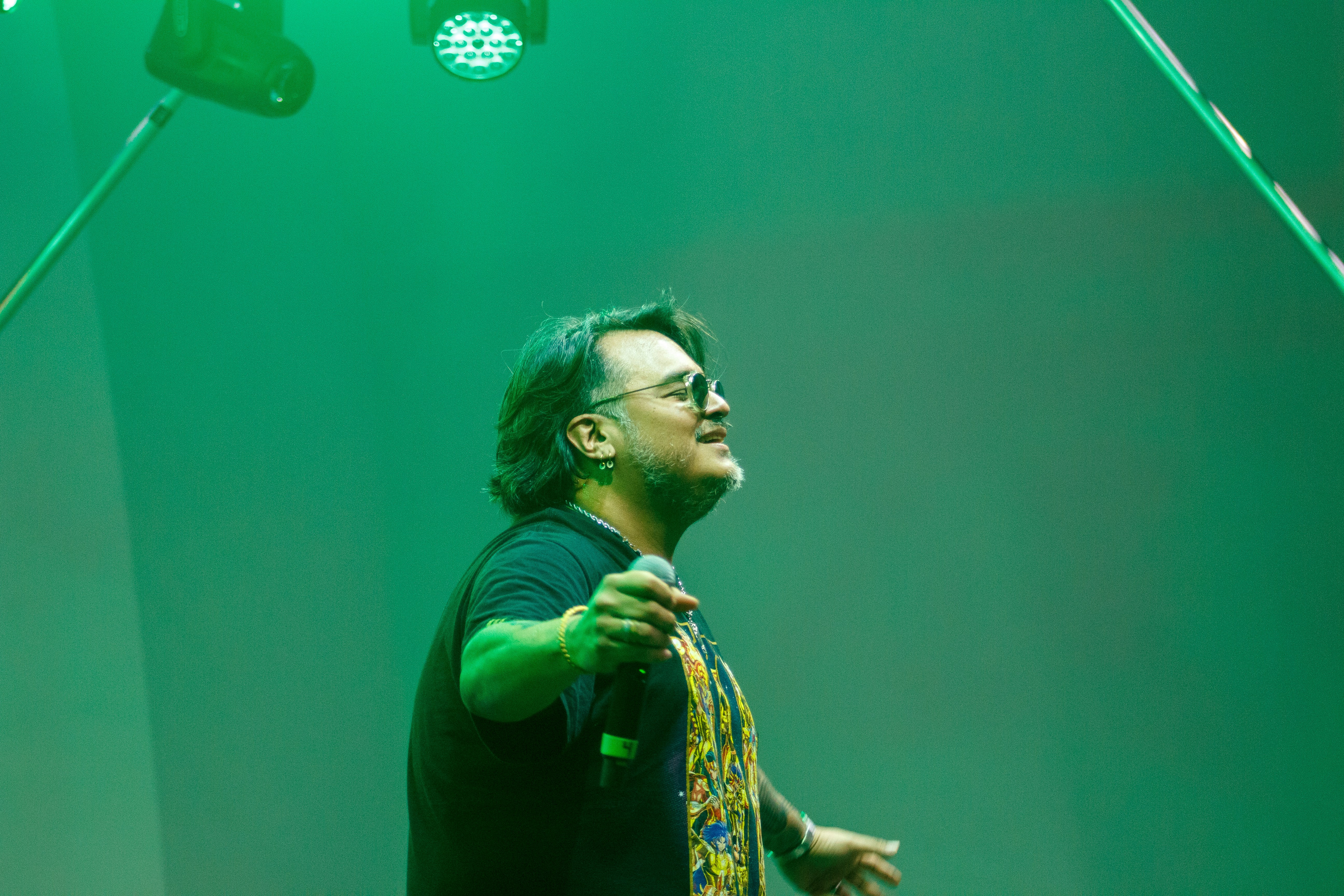 Green Spotlight, Glassy Smile: A Moment with the Stage Veteran