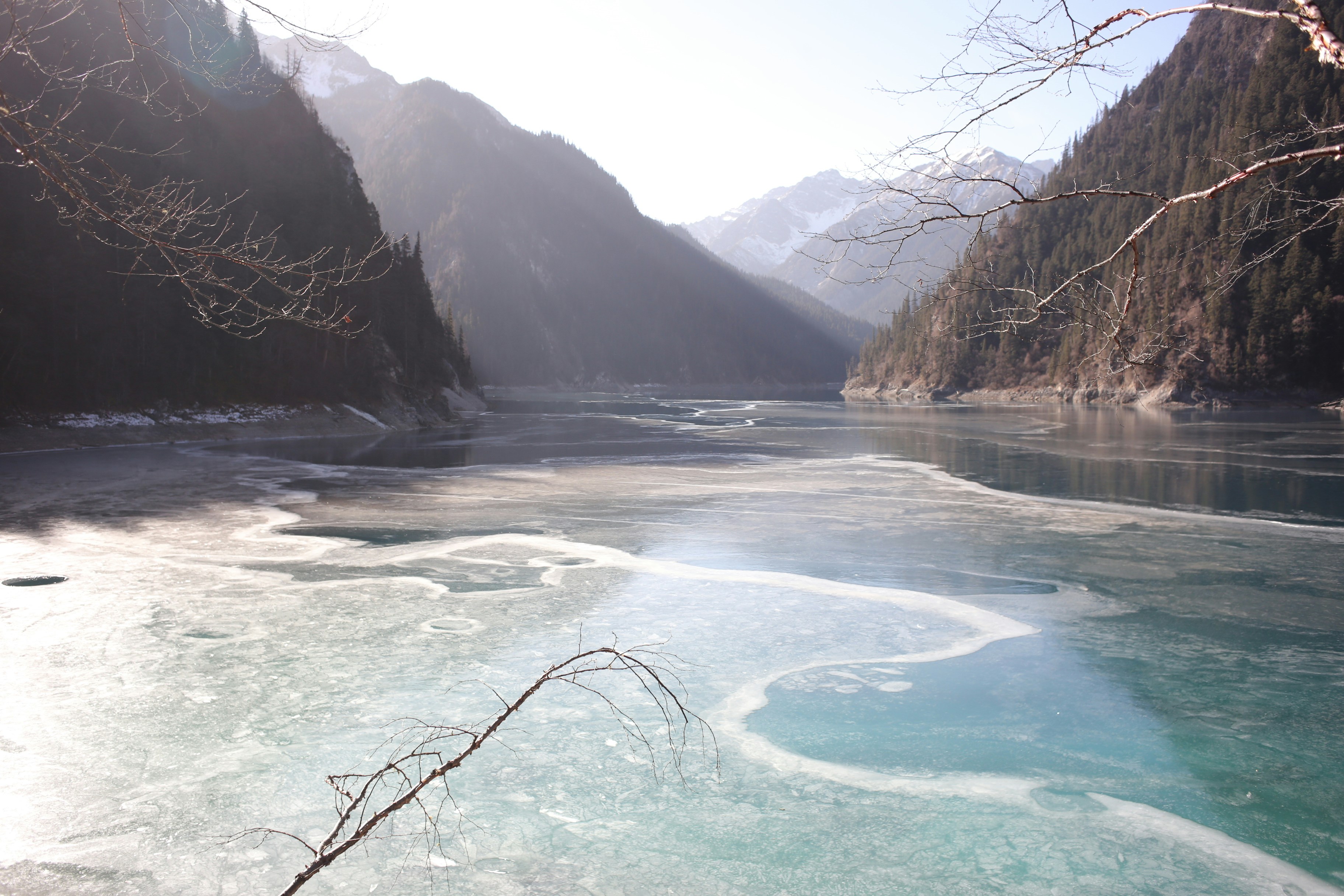 Glacial river corridor under shadowed peaks