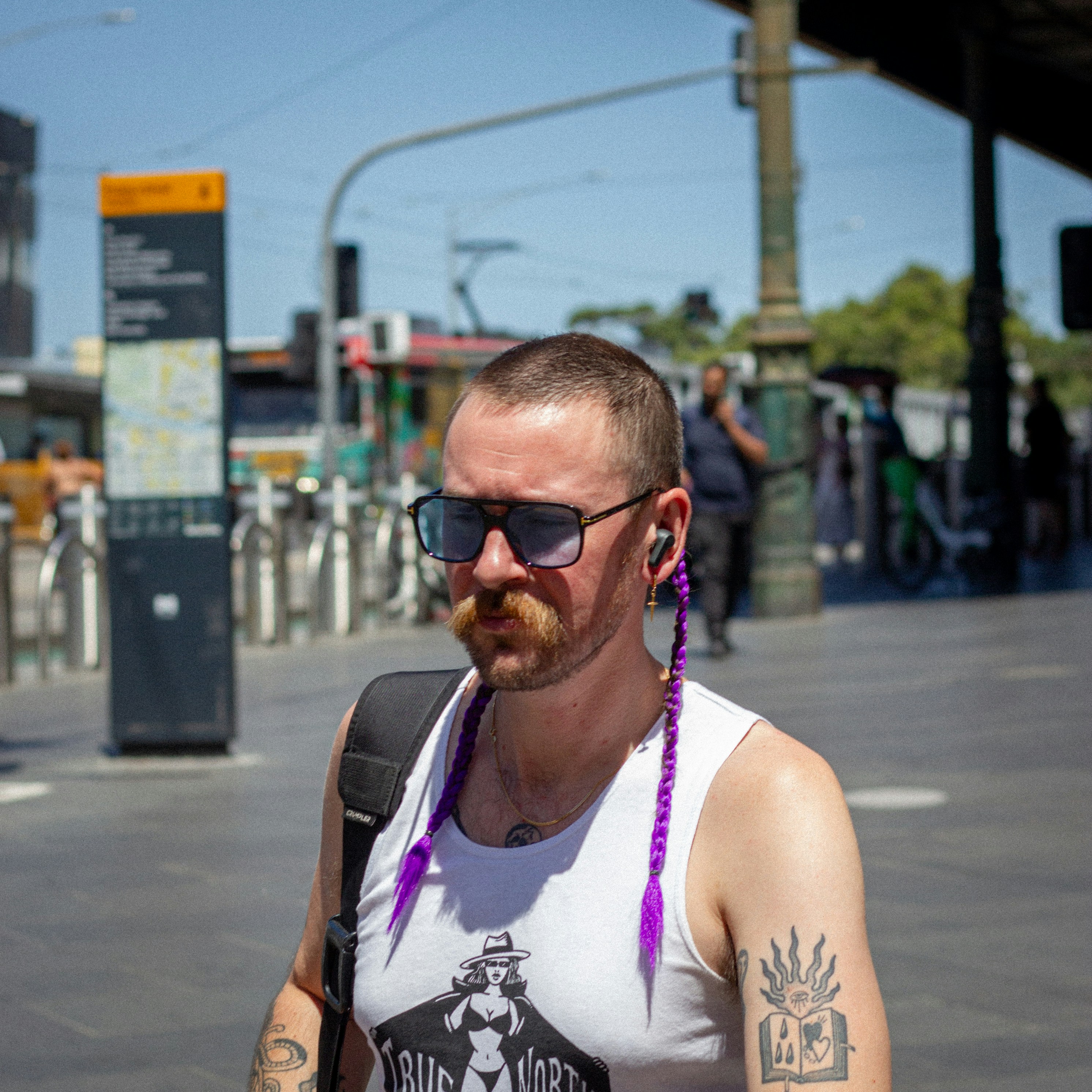Neon-twisted ponytail and urban traveler in a sunlit station