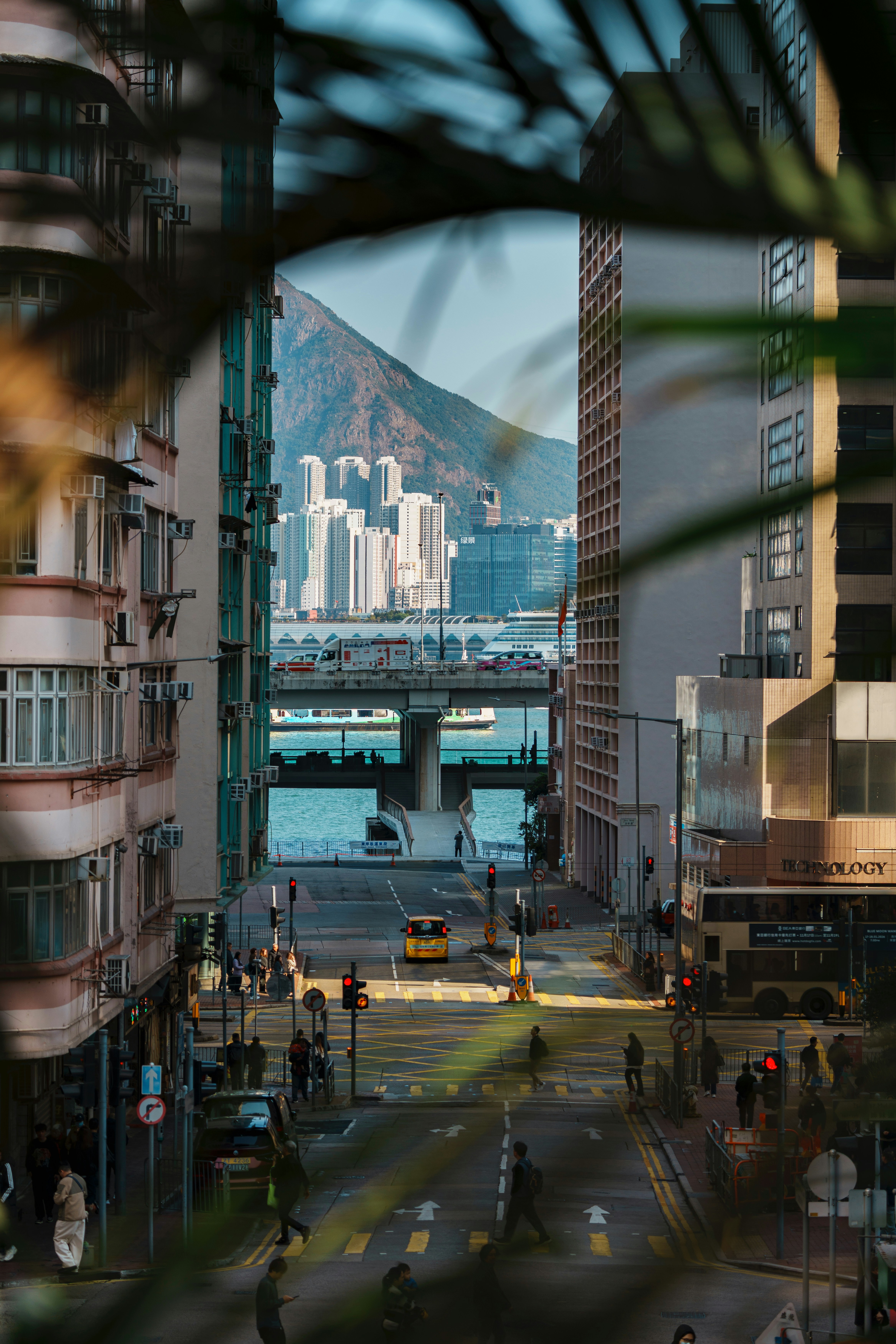 City Canal Through the Frame: A Narrow Street Opens to Harbor Skyscrapers