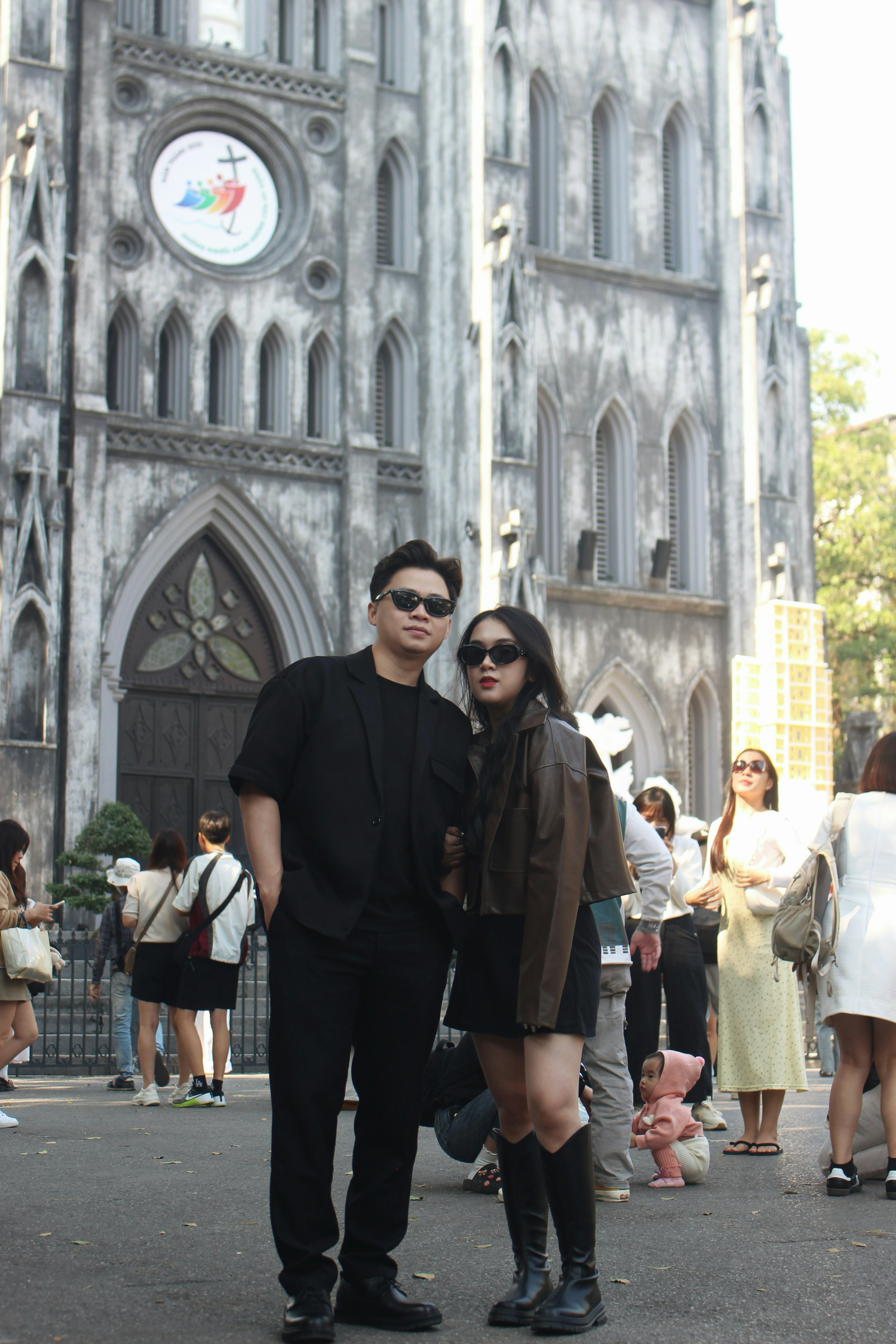 Urban duo in stylish silhouette against a Gothic cathedral backdrop