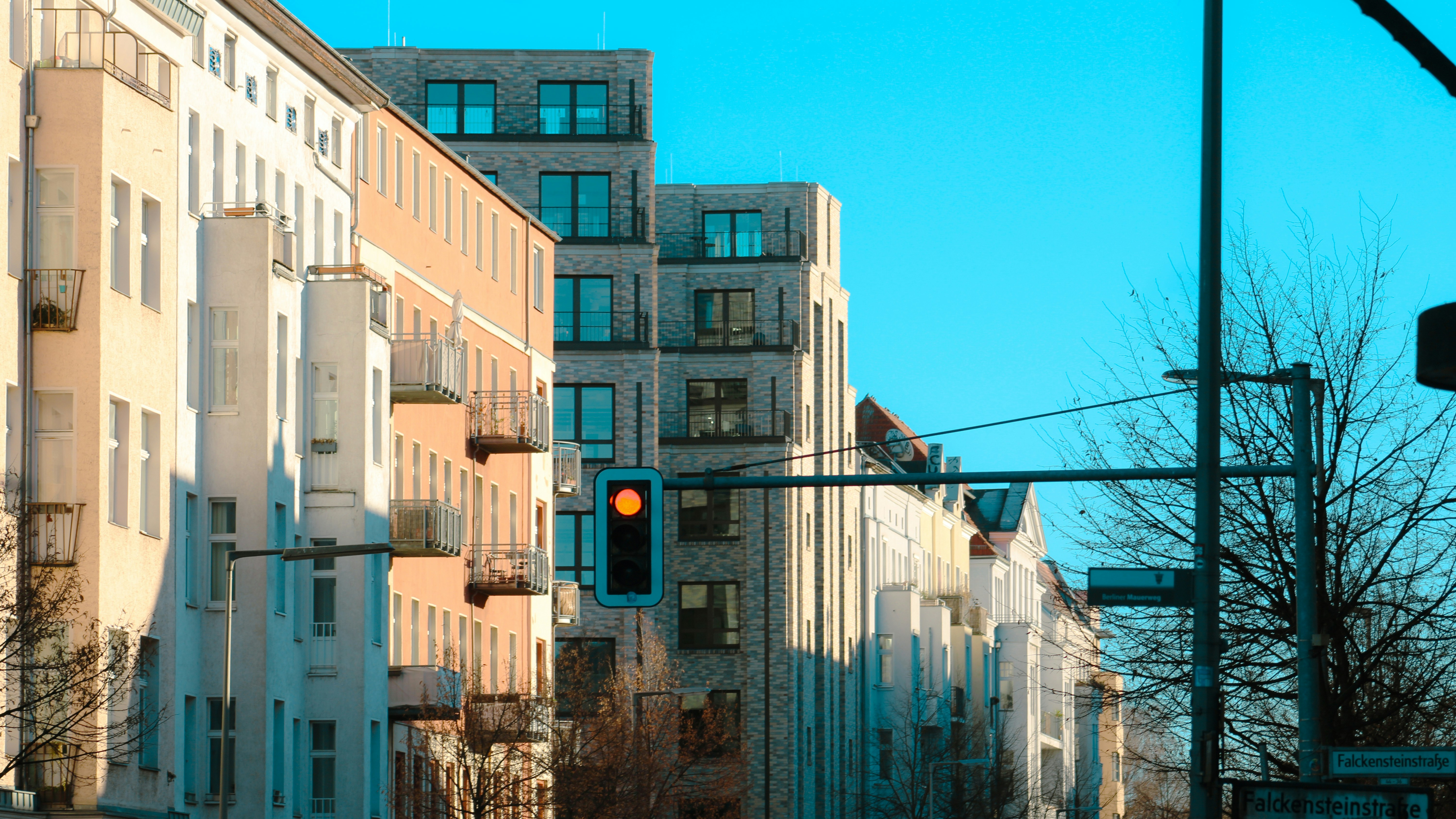 City Street Under a Clear Summer Sky with a Redirecting Traffic Signal