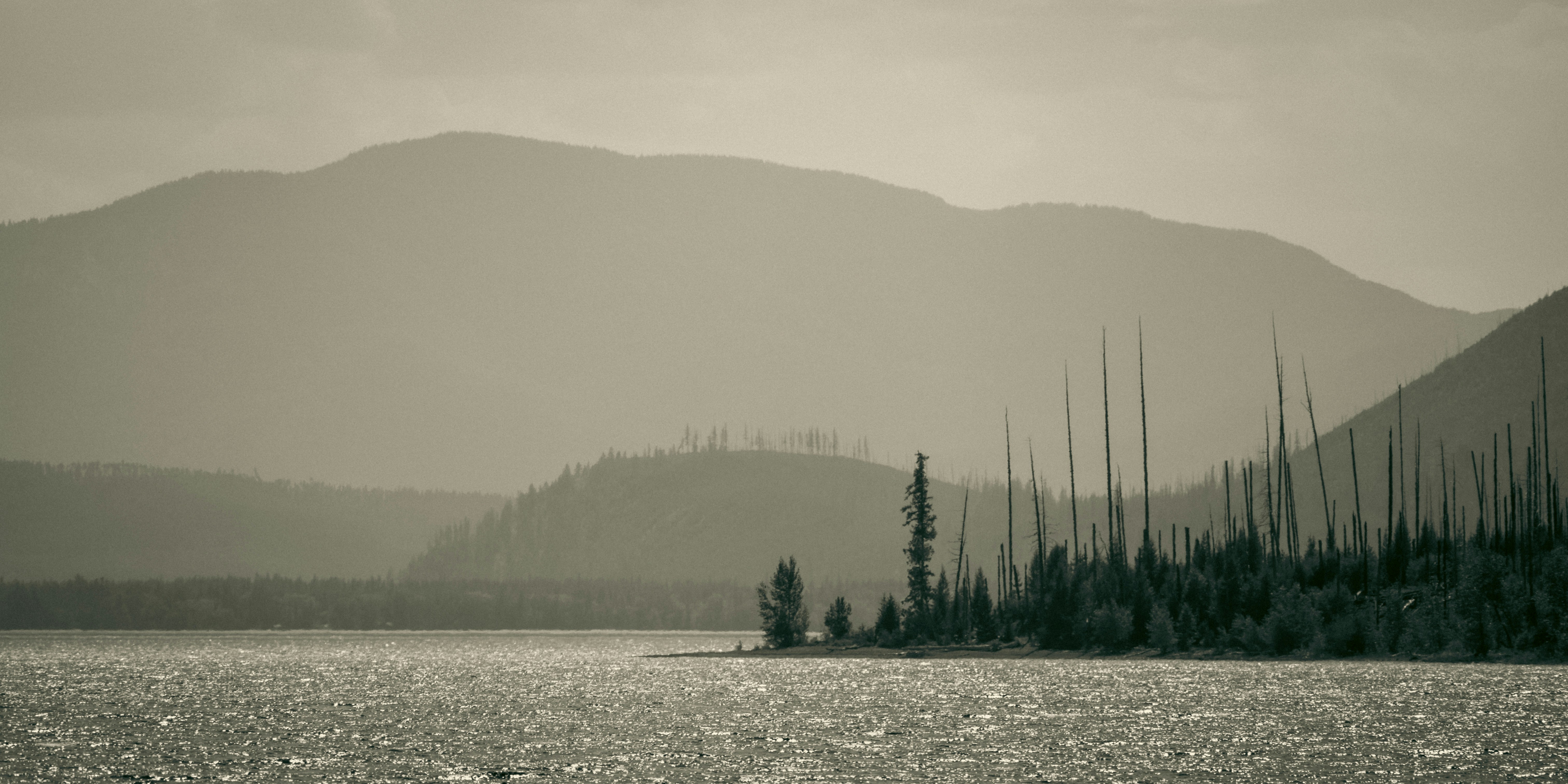 Muted Fjord Silhouette: Distant Mountains Under Soft Light