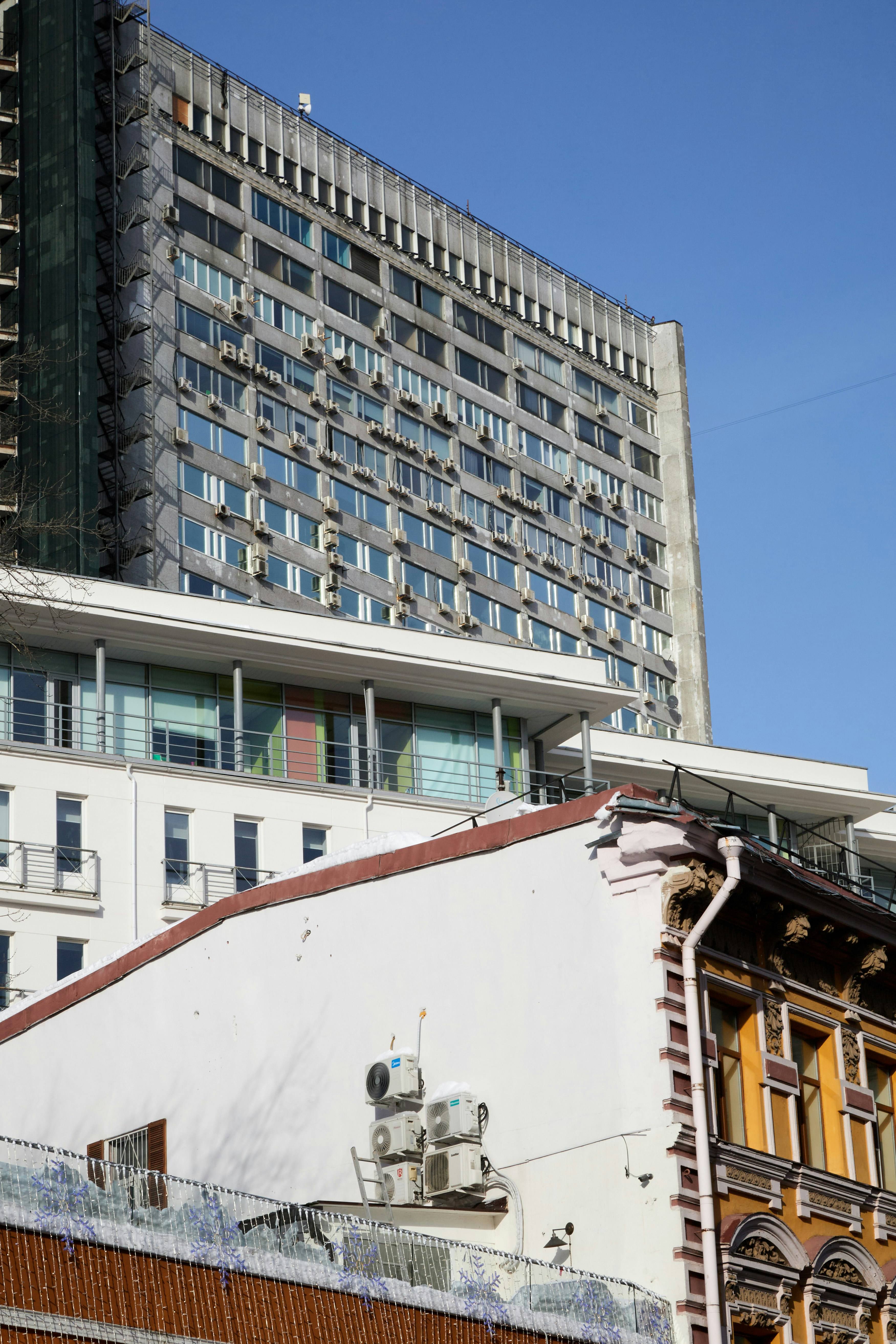 Towering Glass and Painted Facades: Cityscape with a Weathered High-Rloor