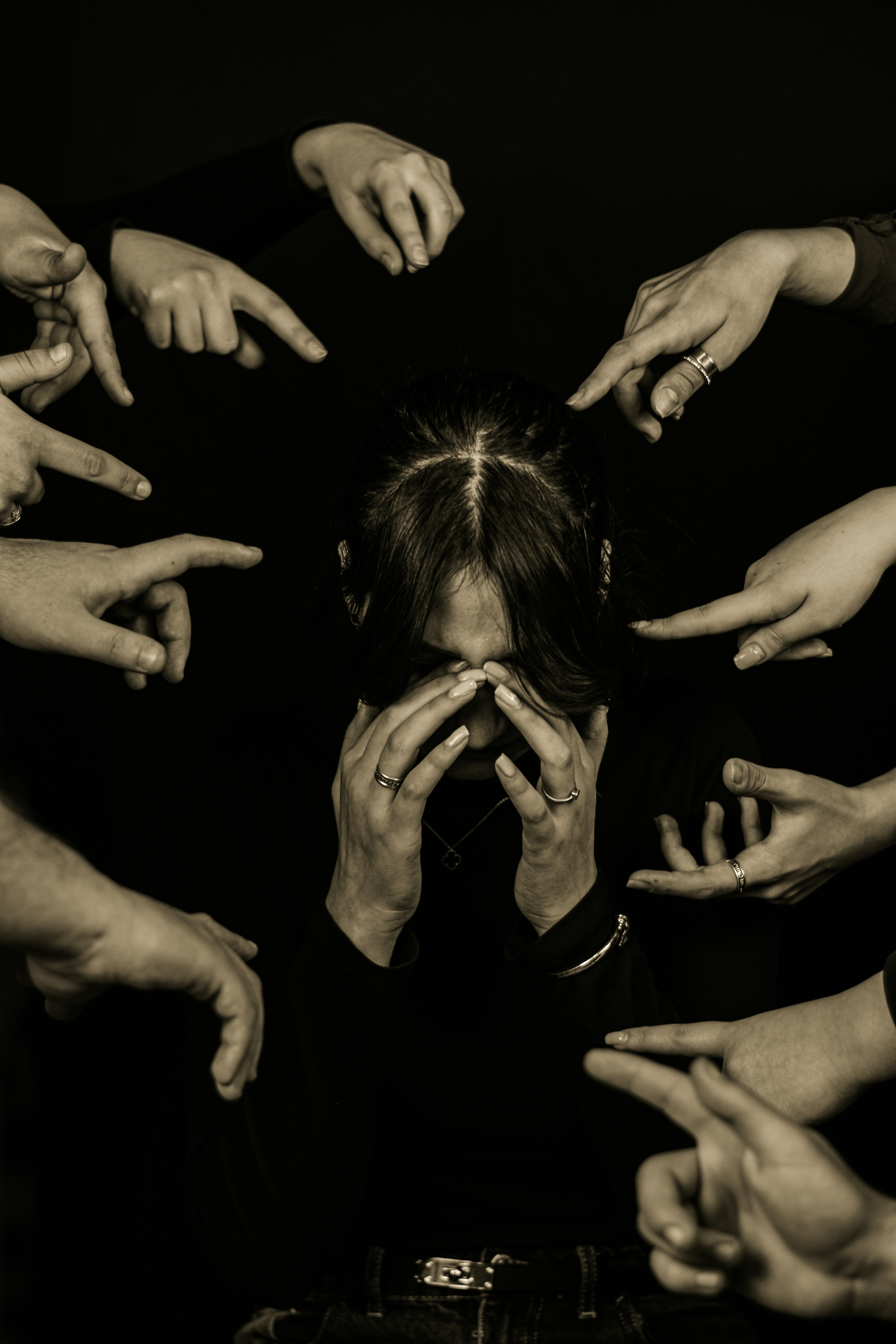 Center of Silence: A Woman Surrounded by Chalked Fingers