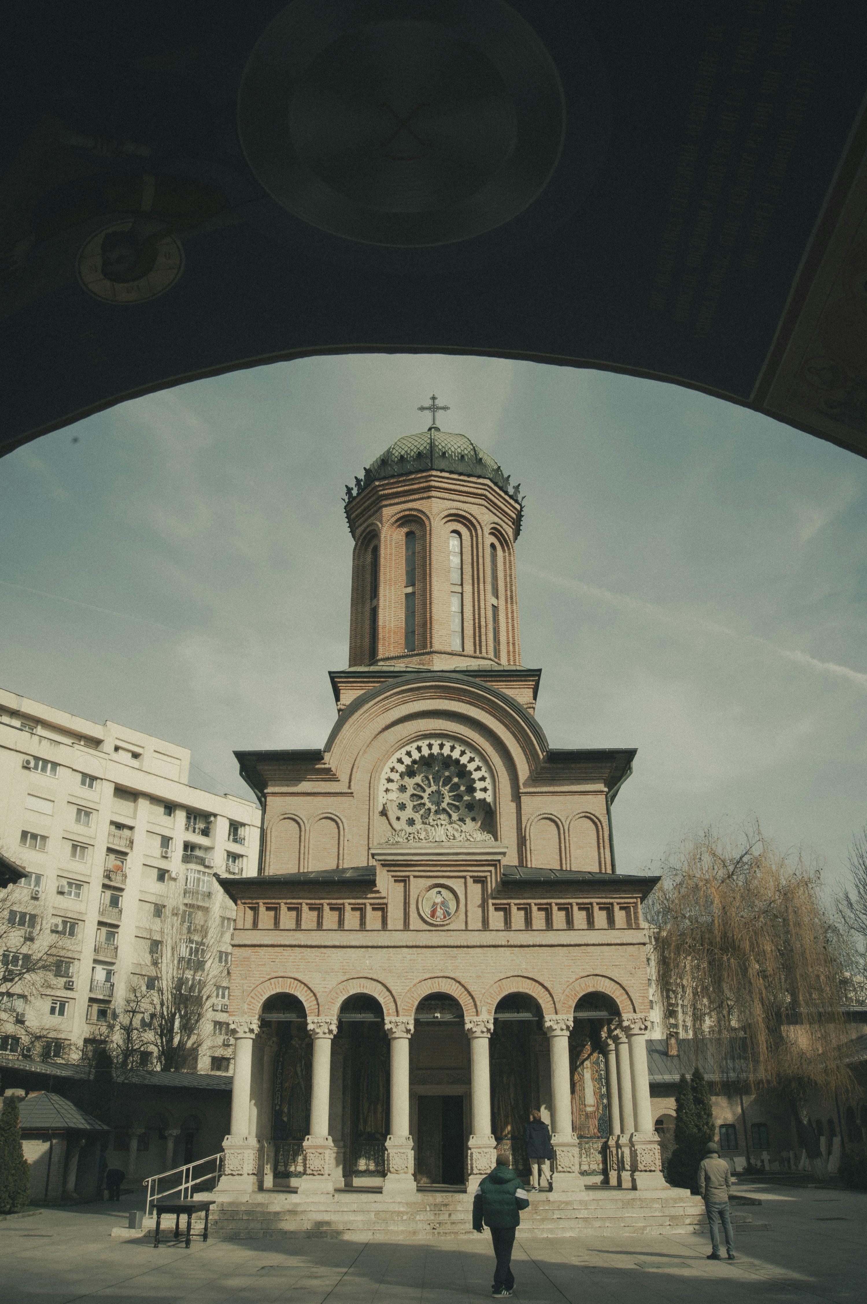 Church in Halo: A Brick Facade Framed by Archway and Sky