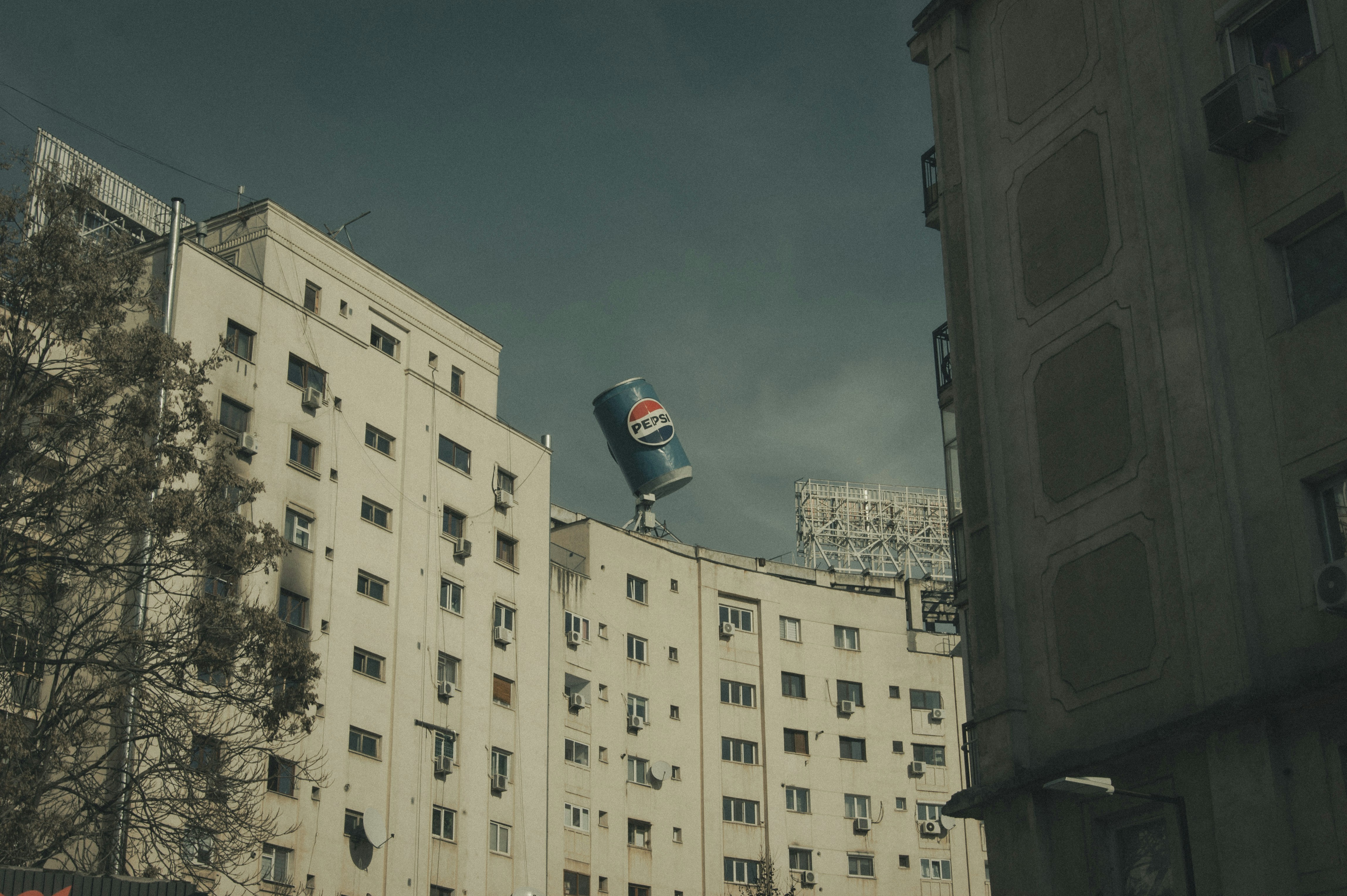 Cityscape with a Suspended Soda Can: A Moment Under a Dated Sky