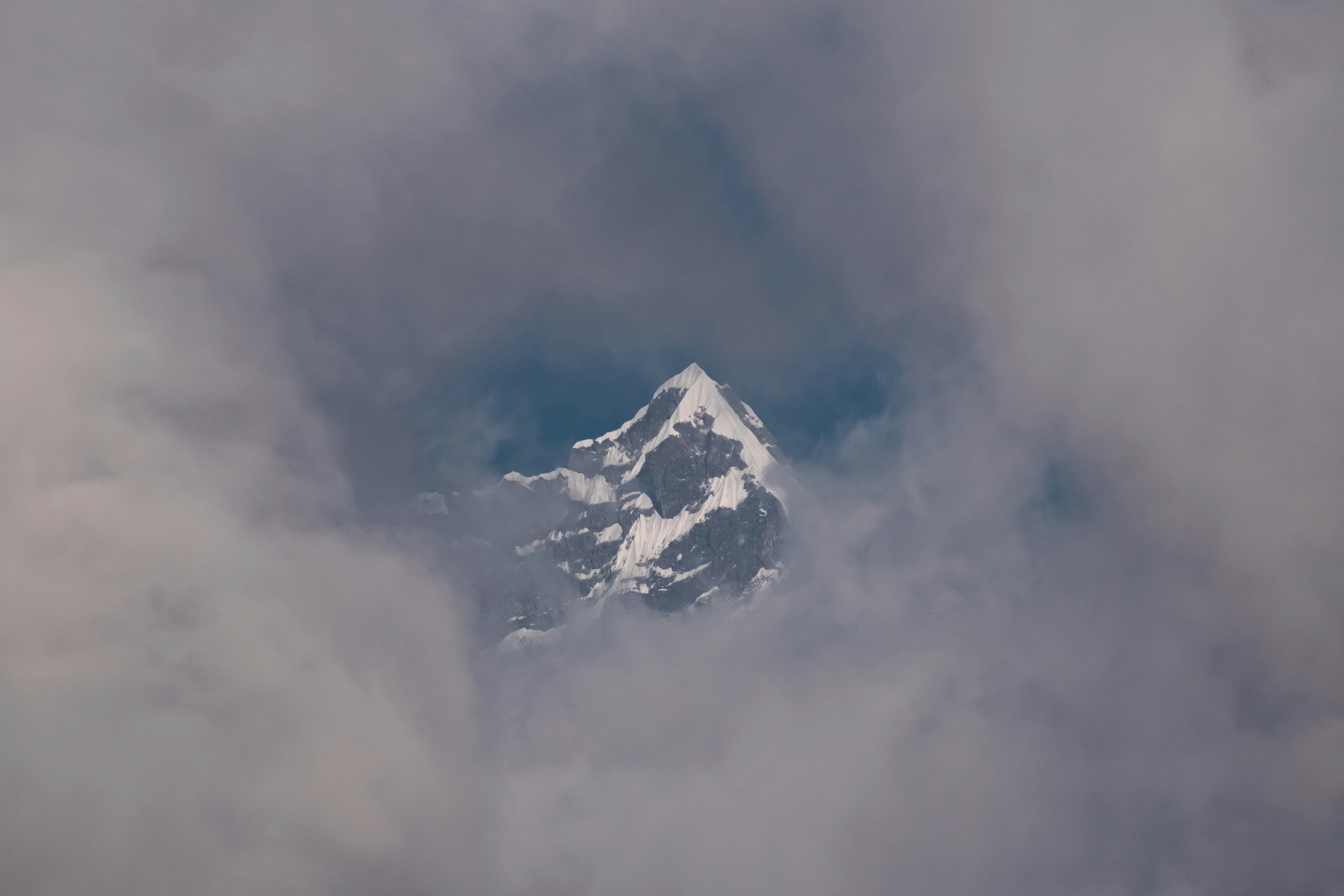  summit peak emerging through a sea of clouds