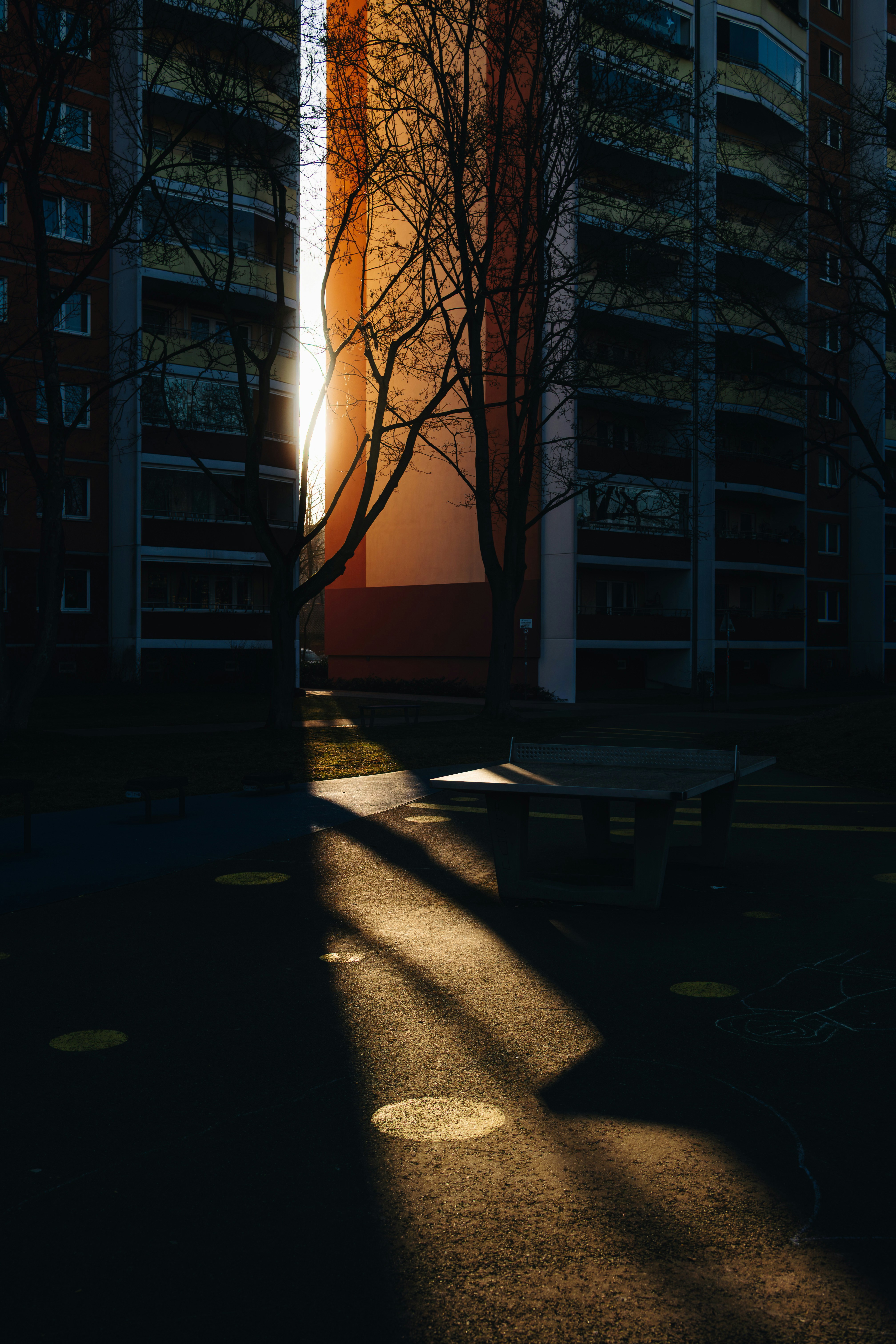 Sunlight streams between apartment buildings onto a courtyard.