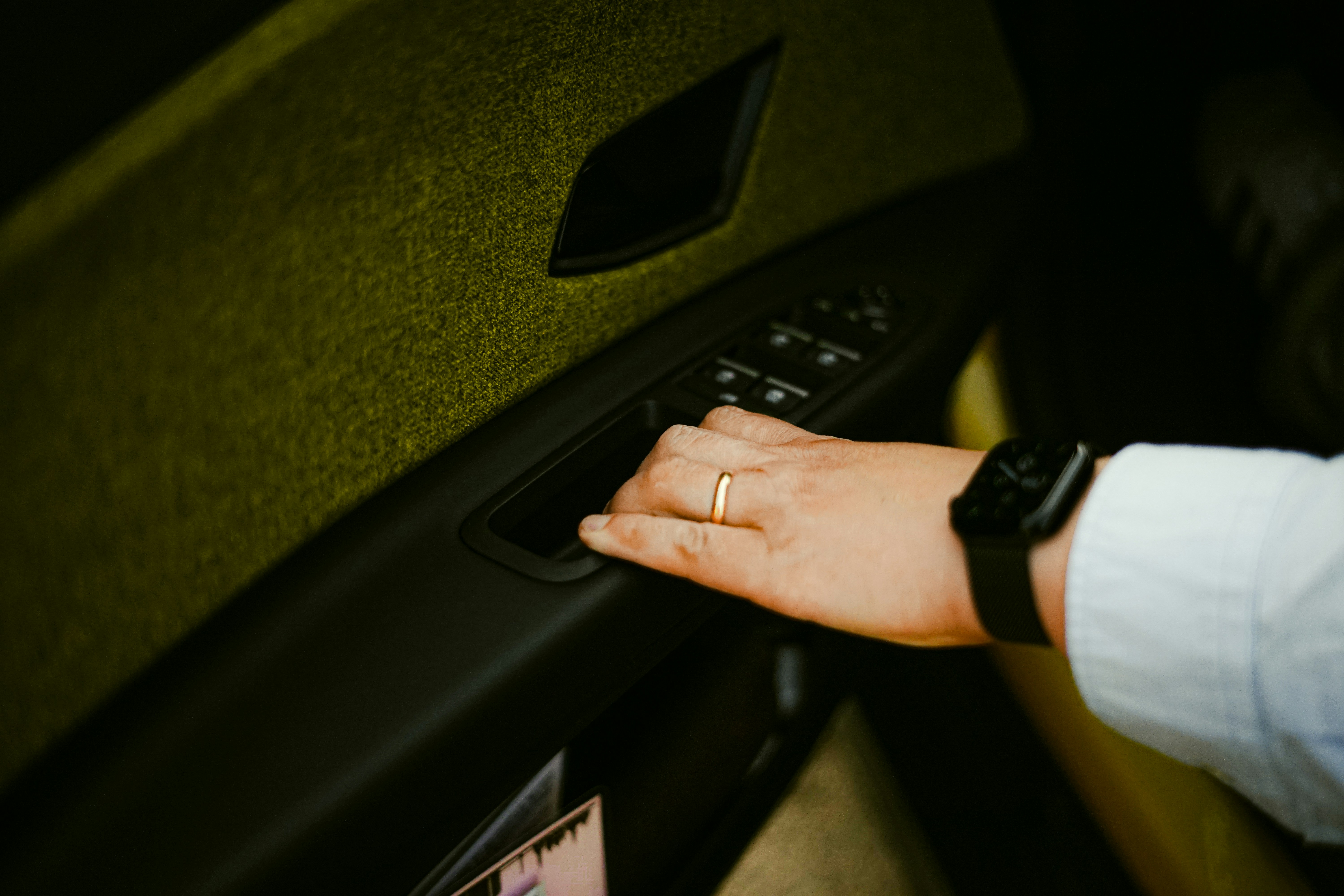 Inside the Car: A Close-Up of a Hand on the Door Panel