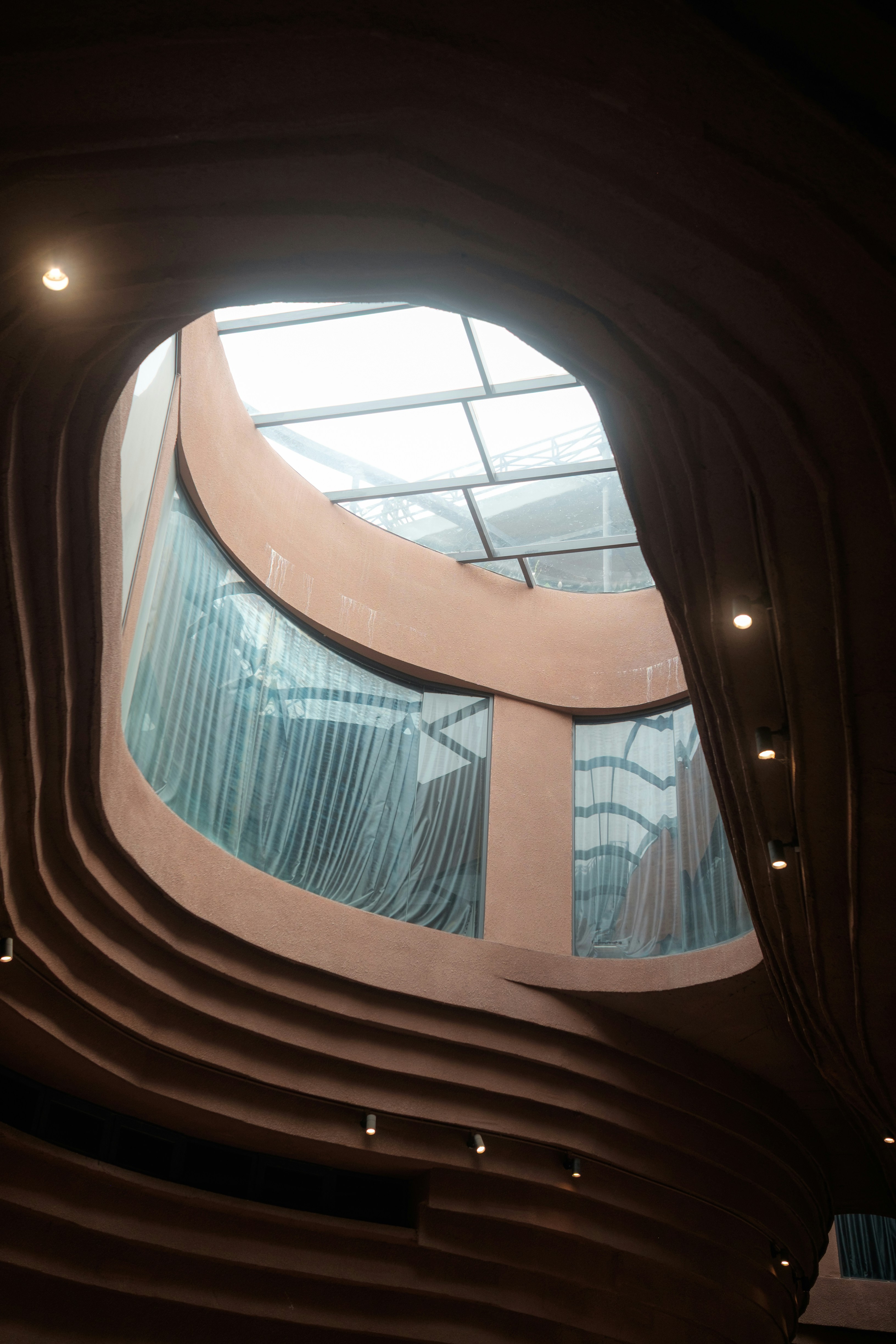 Spiral Atrium: Curves of Light Inside a Civilized Canyon