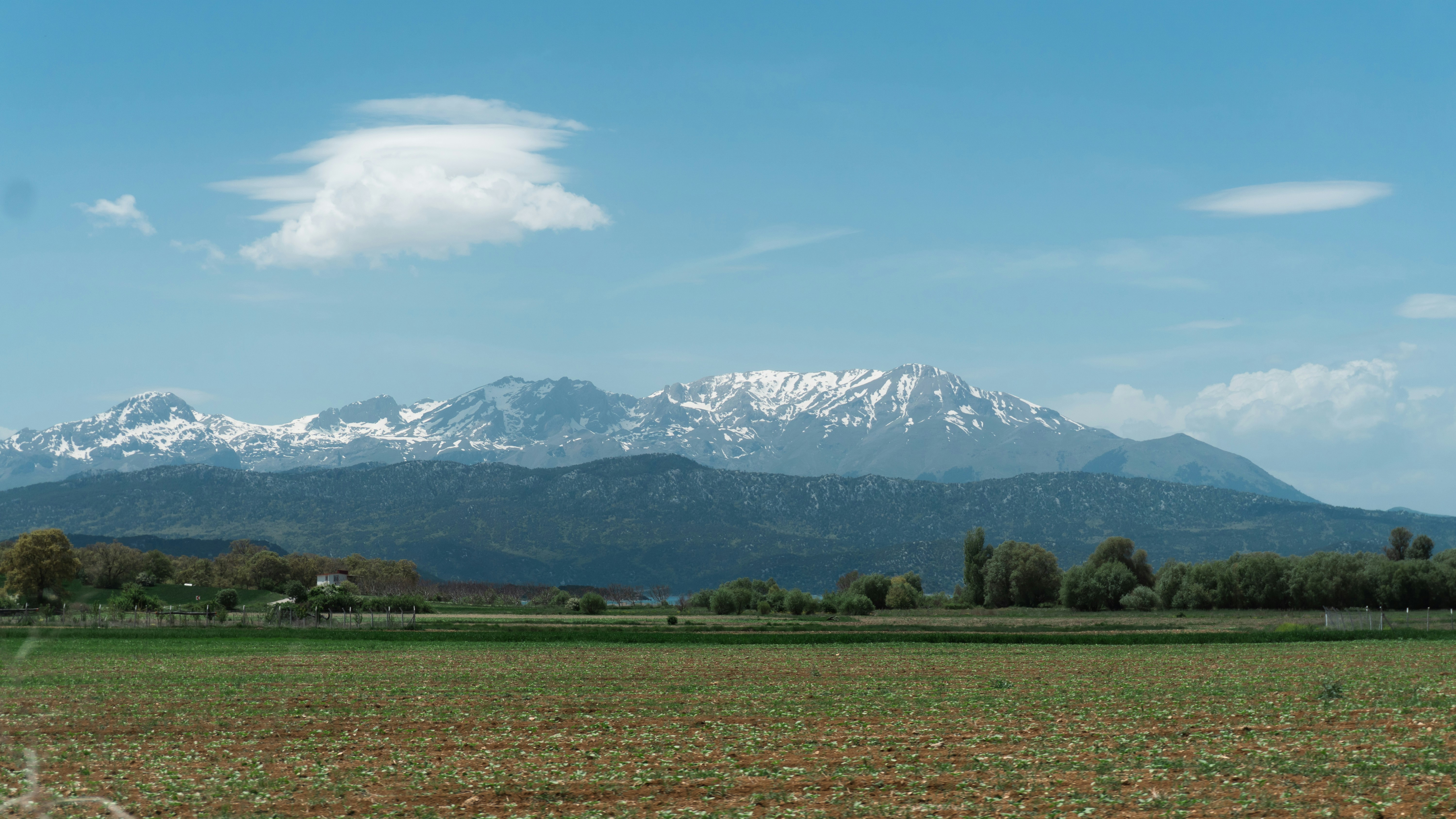 Snow-kissed Peaks Over a Quiet Meadow