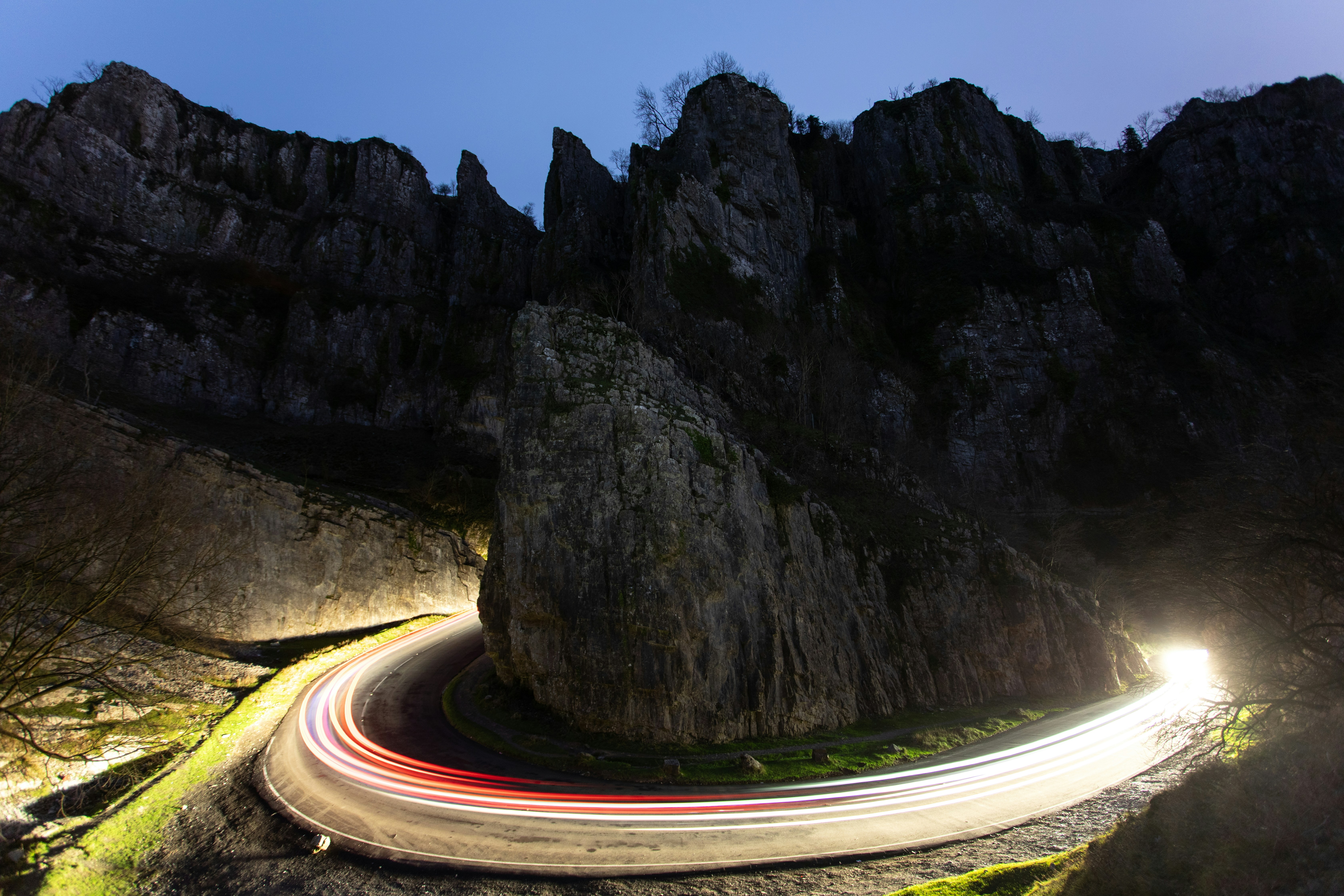 Curved Lanterns: Light Trails Around a Moonlit Pass