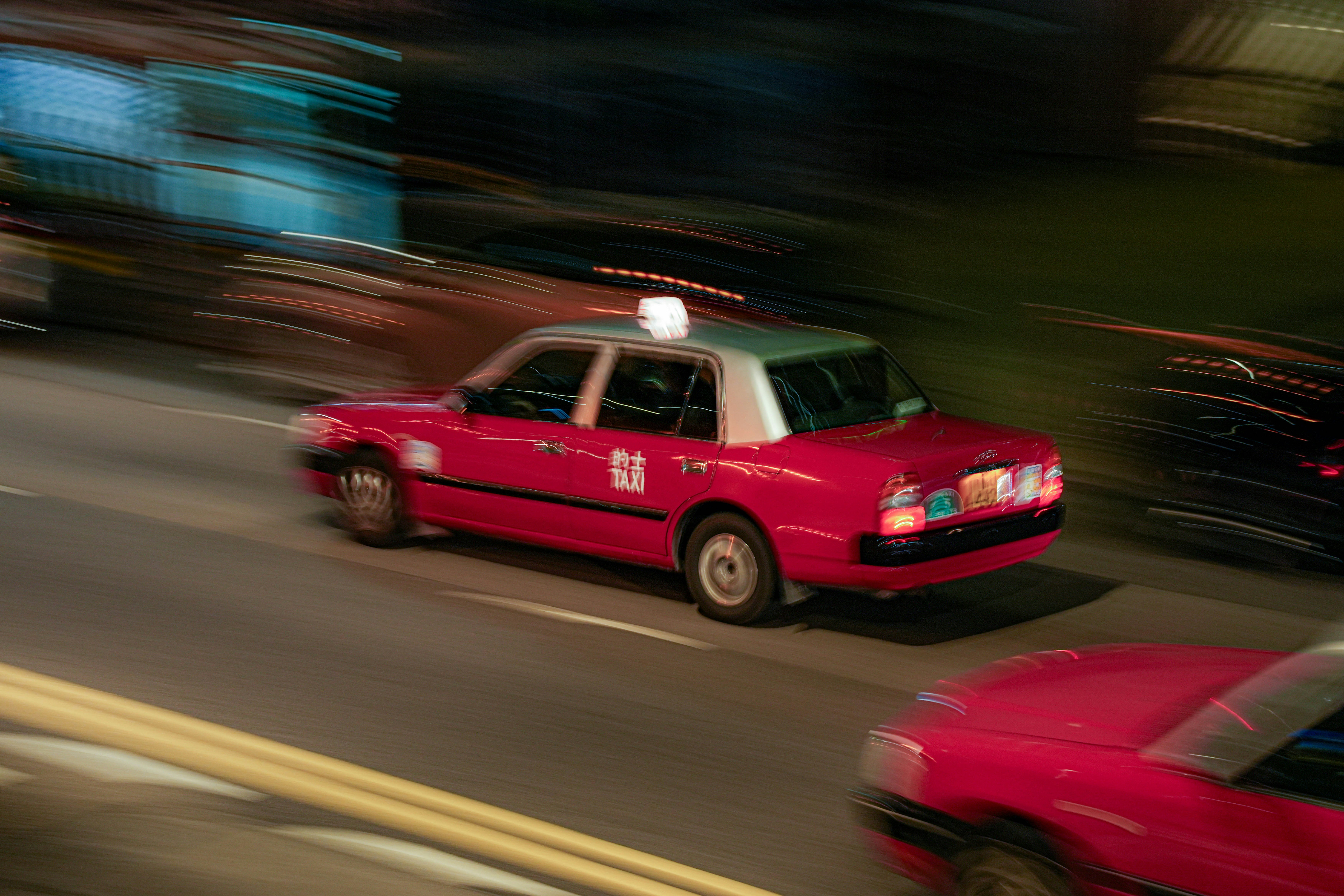 Blurry City Taxi in Motion: A Crimson Cab in the Night Rush