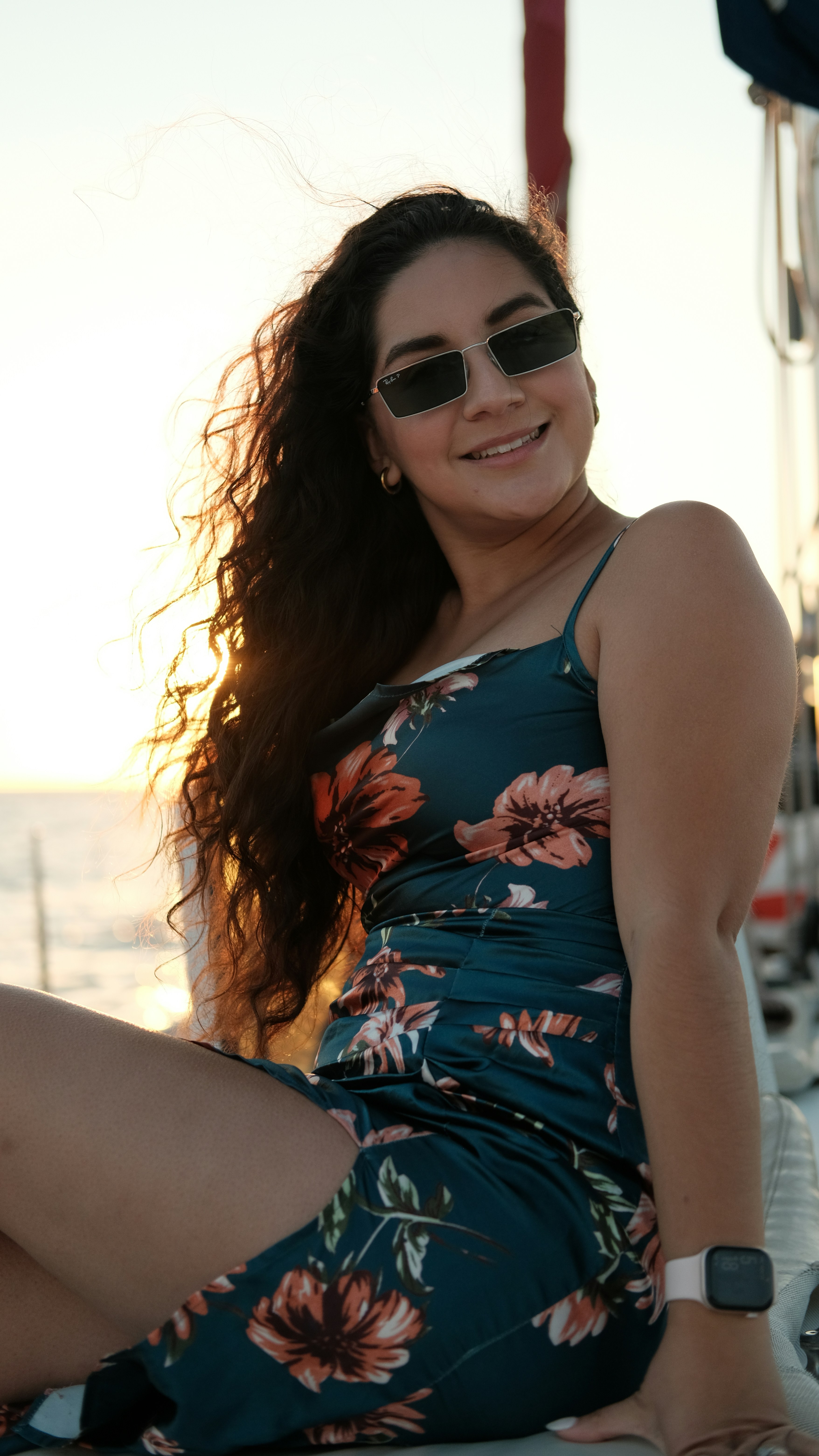 Sunset Glow and Floral Attire: Portrait Aboard the Sailboat
