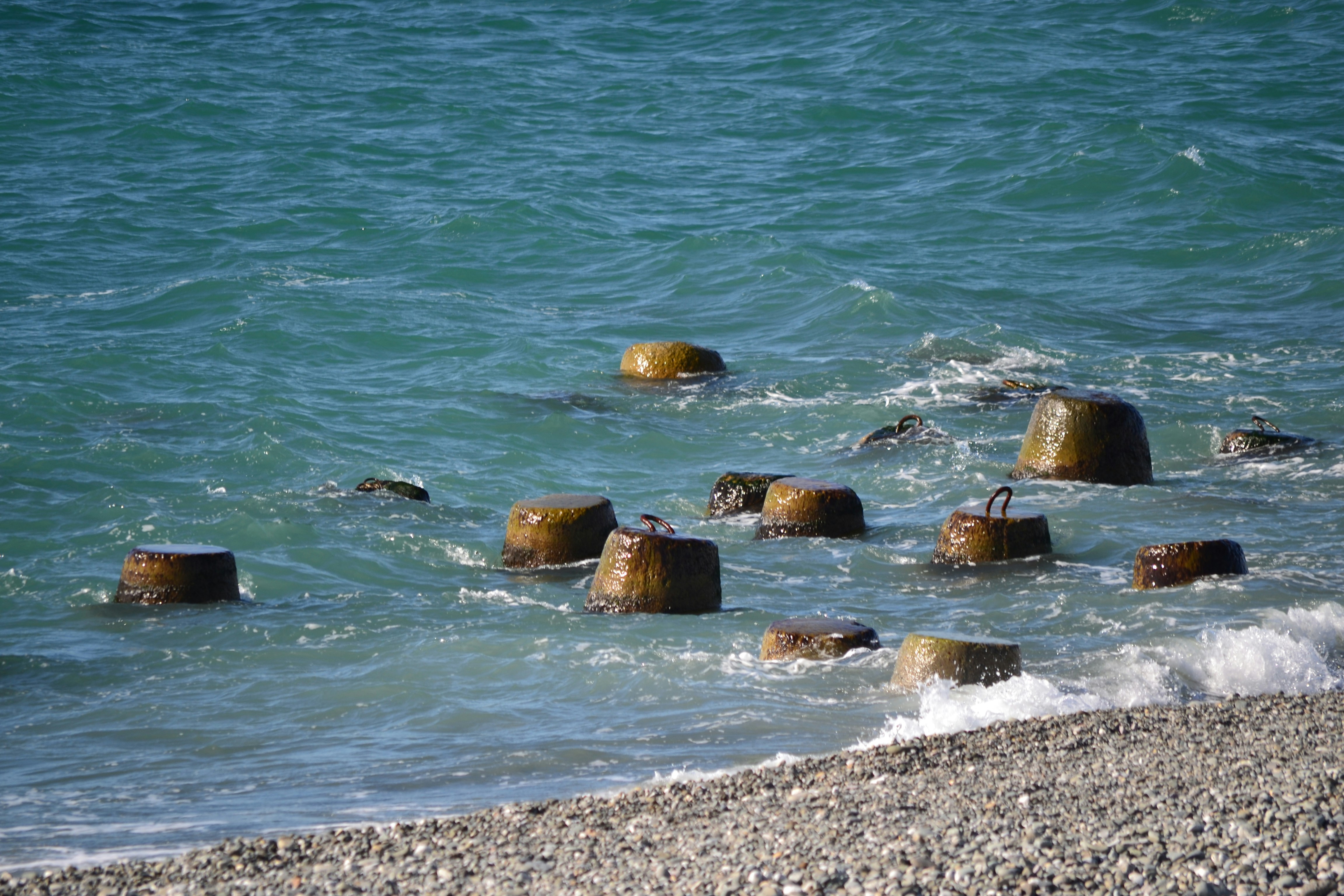 Pebble Breakers: A Quiet Shore Interrupts Blue Waves