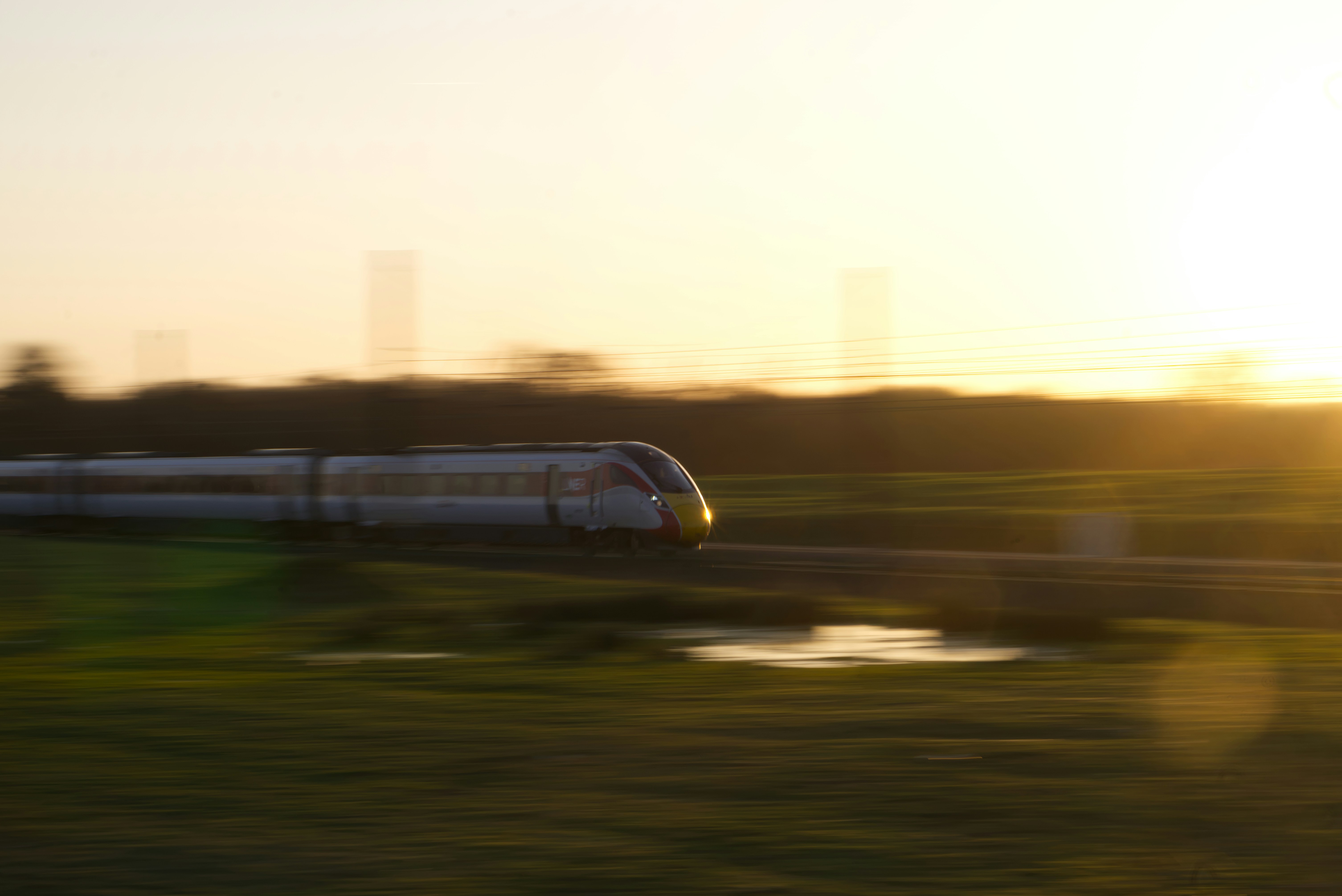 Sunlit Bullet: a high-speed train slices through a hazy golden hour