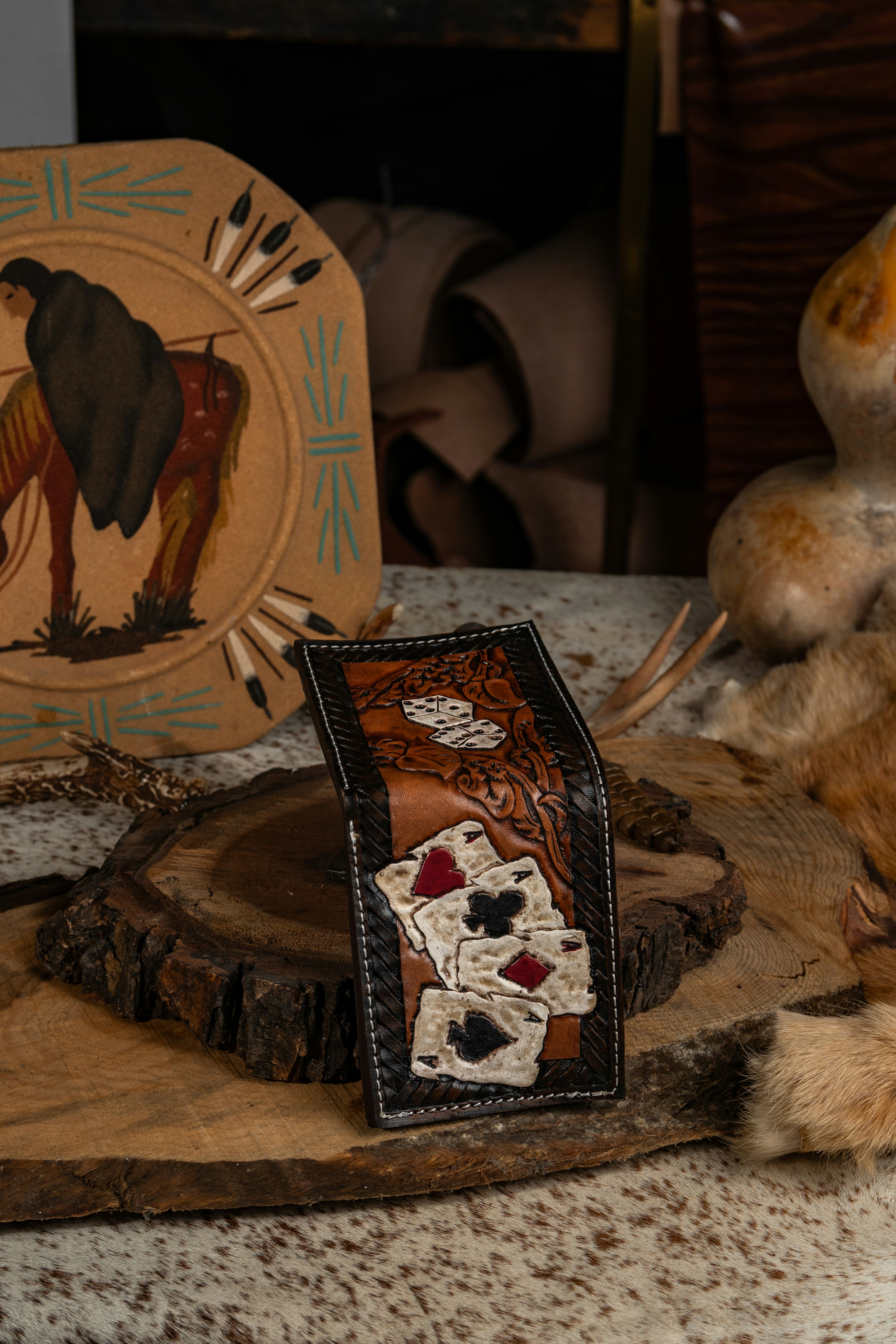 Cardboard Cowboys: Leather Wallet with Poker Chips on a Rustic Display