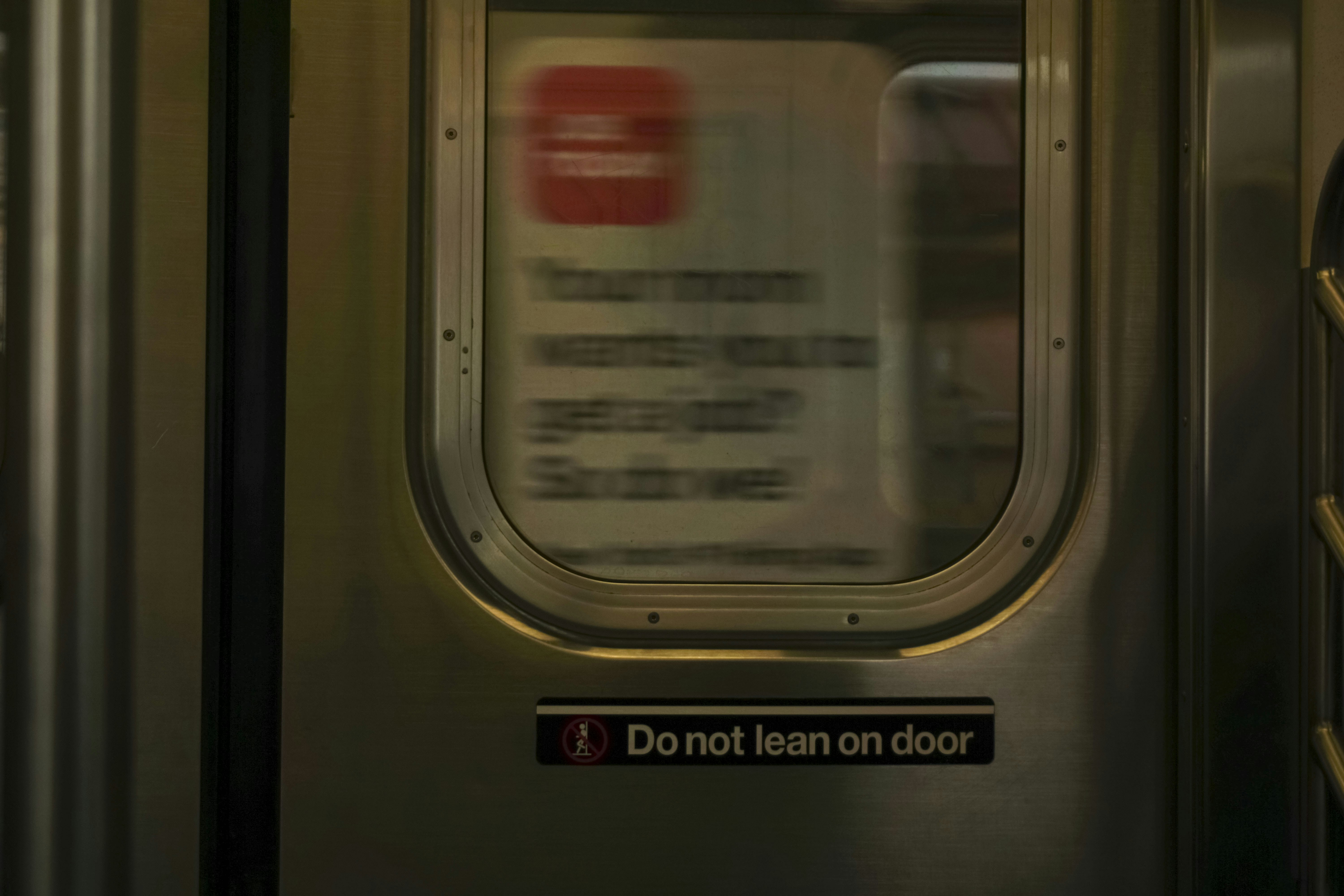 Morning Ride: Blurred Safety Sign in a Quiet Subway Car