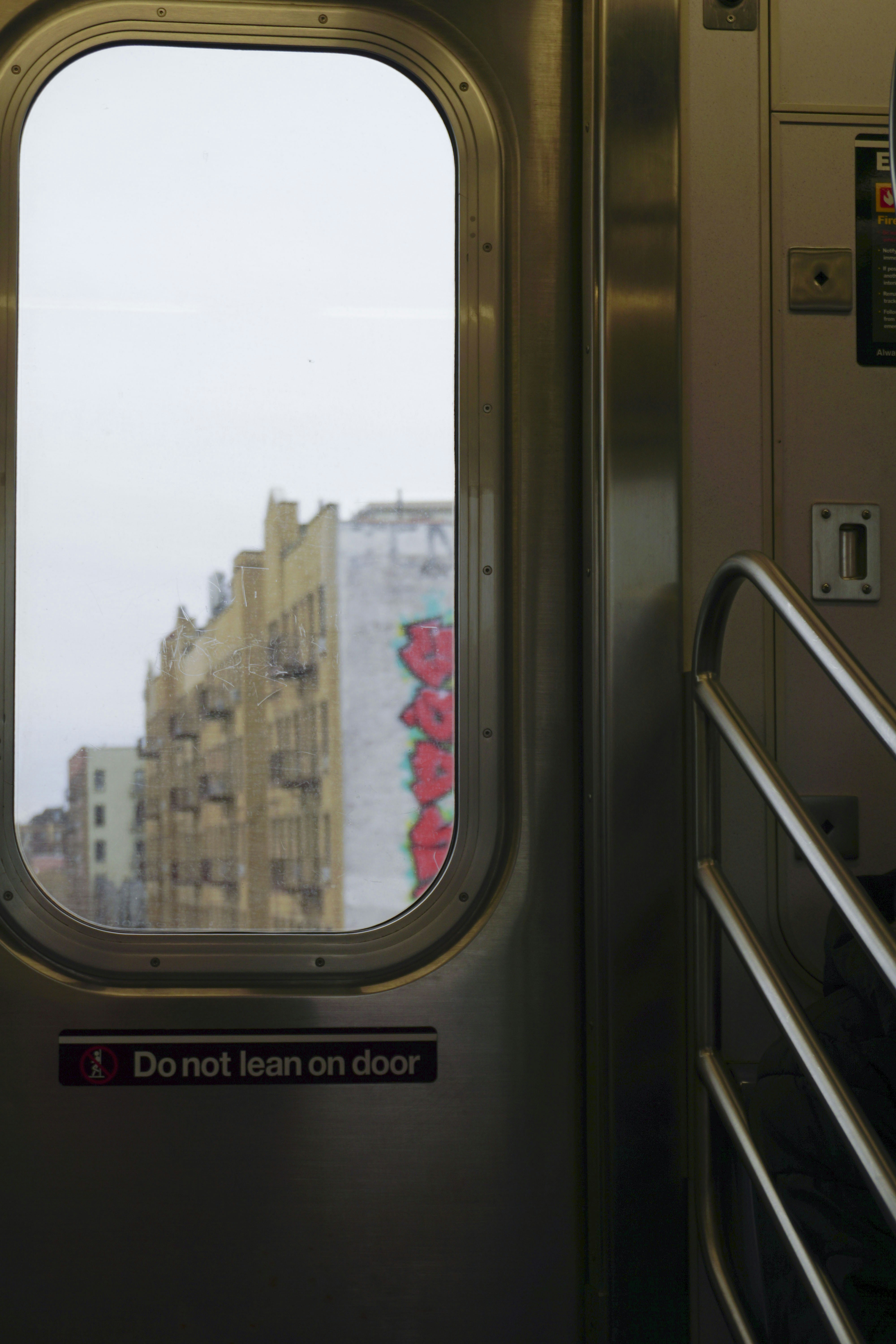 Urban Train Window: Neon Graffiti Framing the City