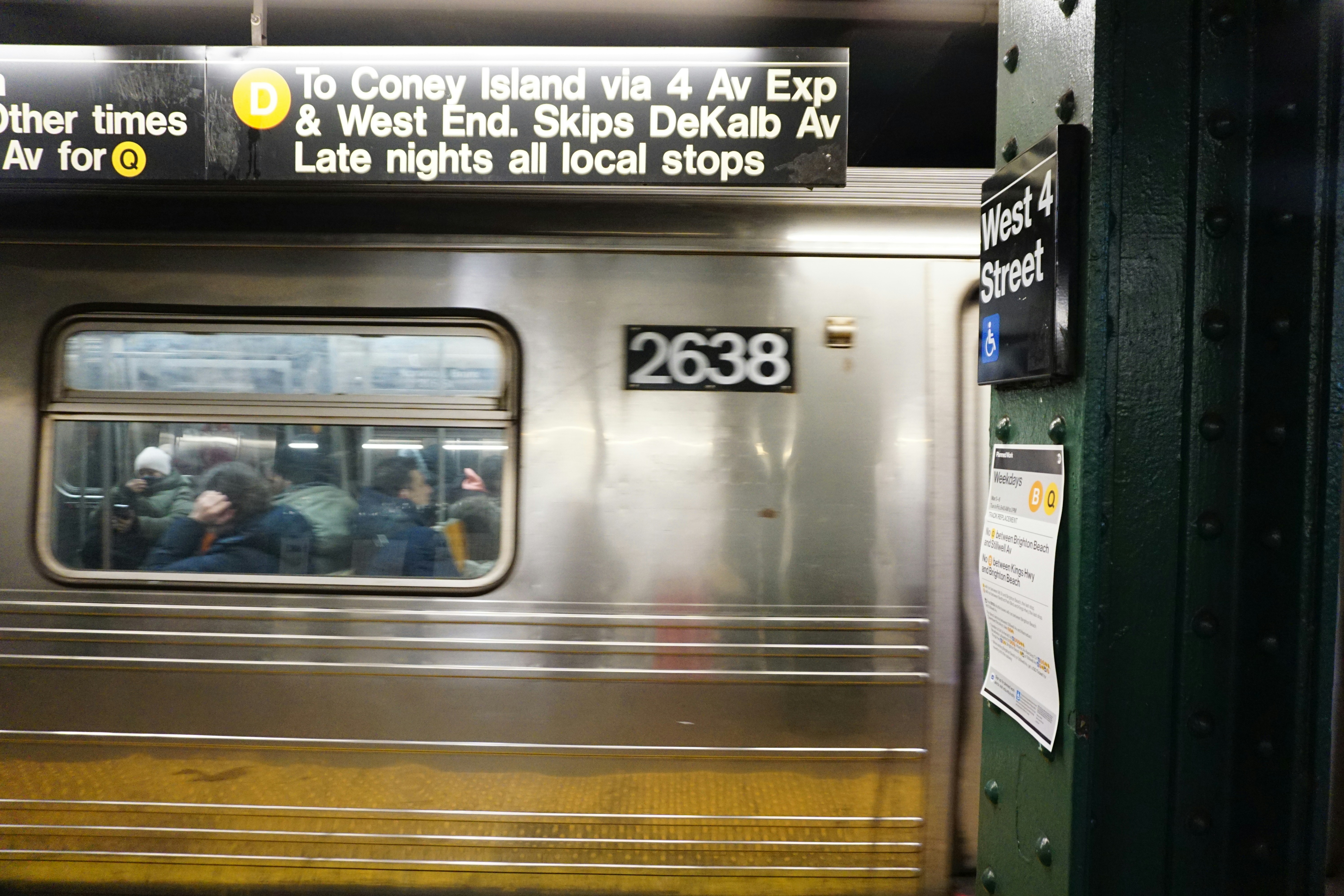 Metallic Train Window: Subway Car with Distant Riders