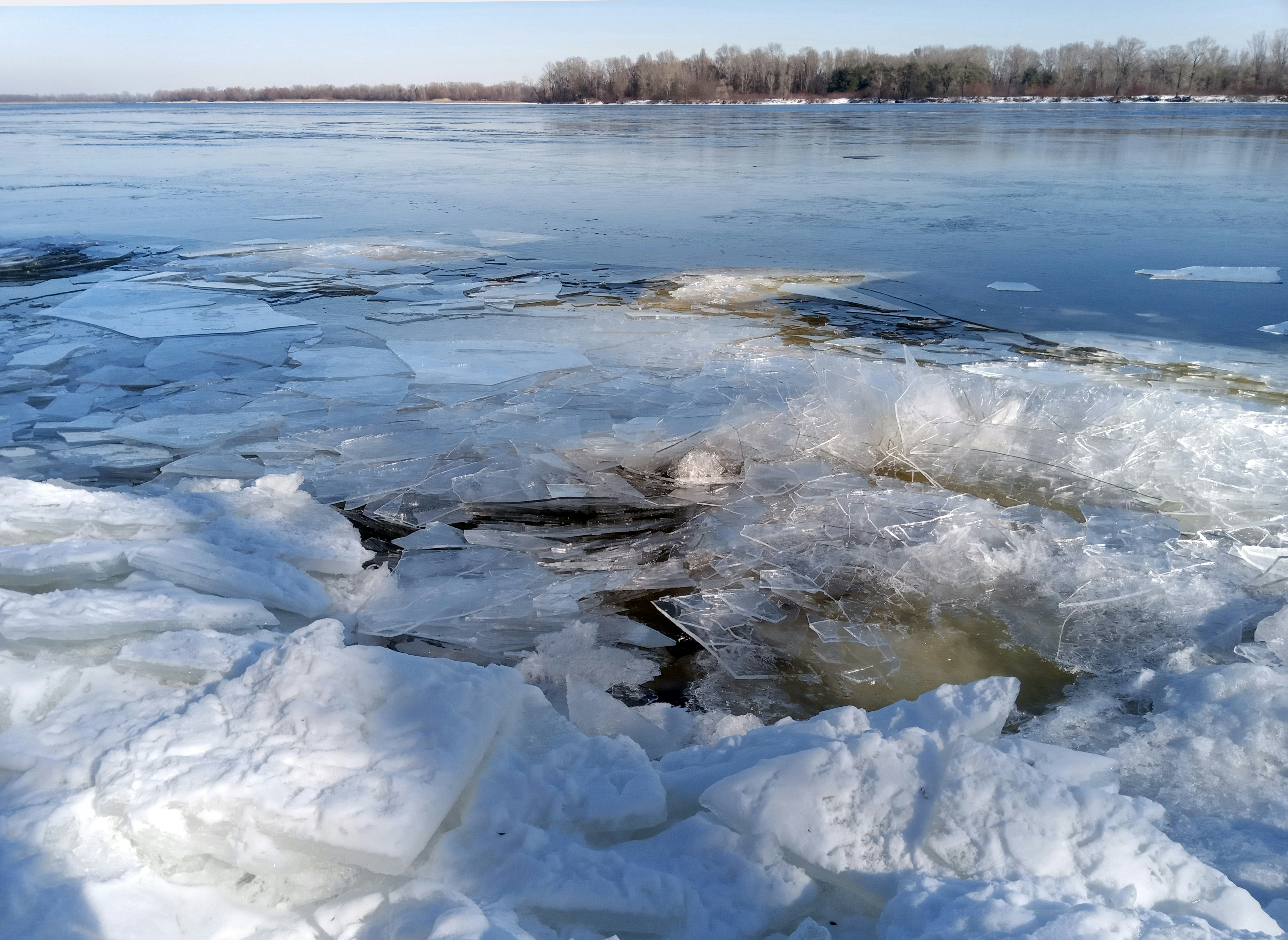 Ice floes floating on a calm river surface