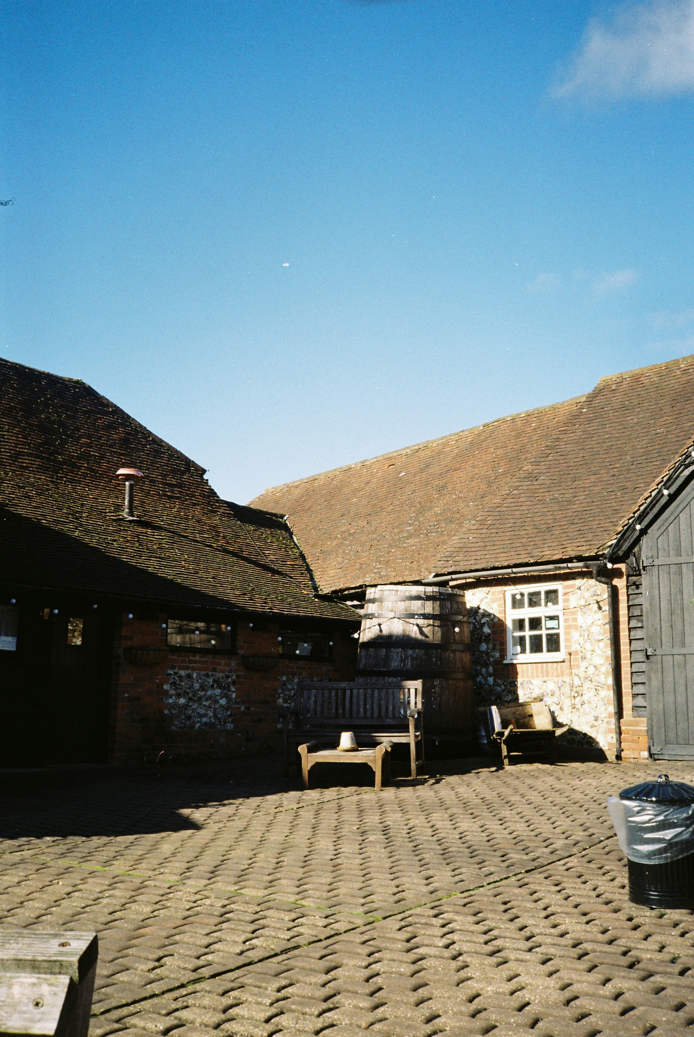 Courtyard with rustic buildings and wooden benches