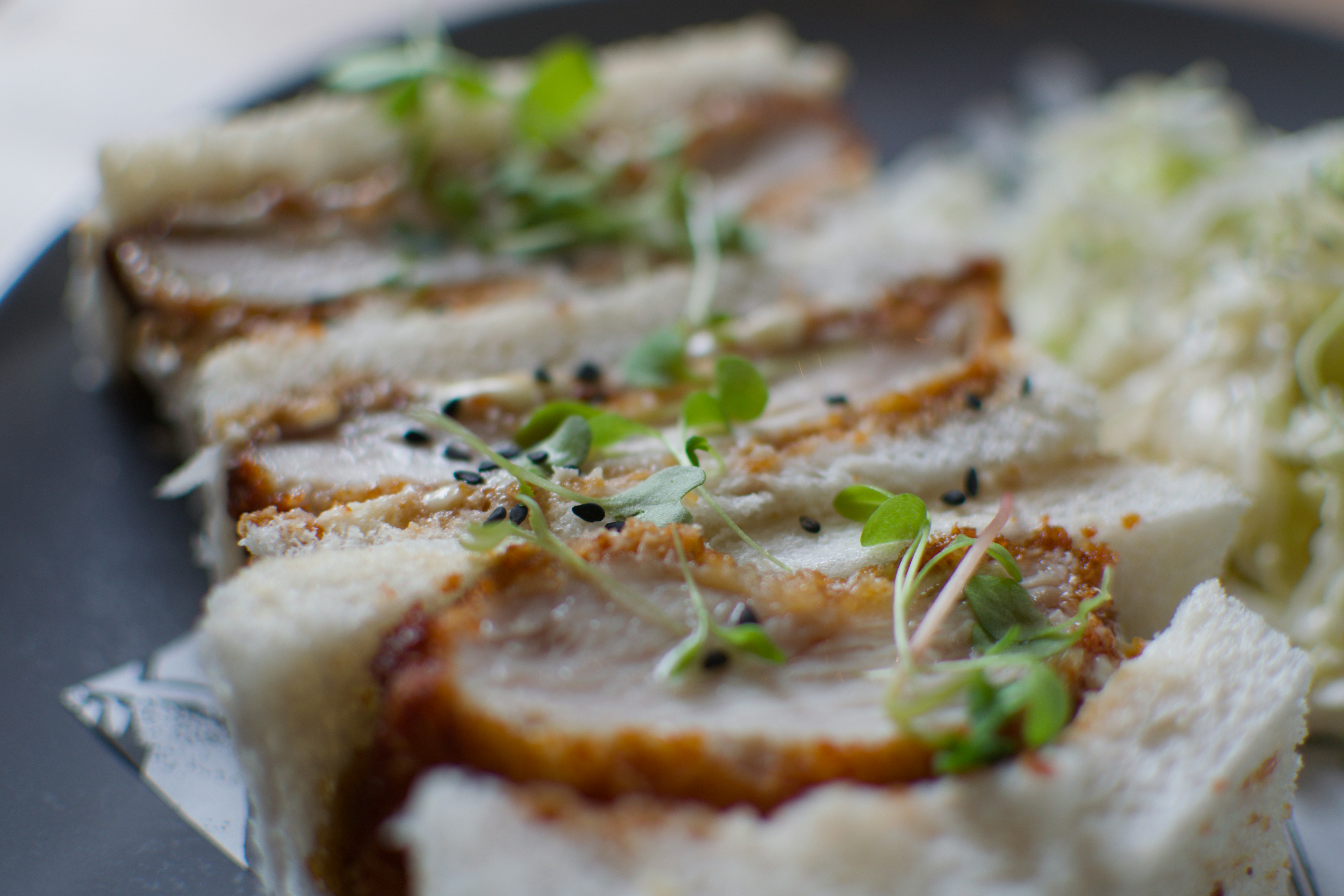 Herbed roasted pork medallions arranged on a bed of crisp bread