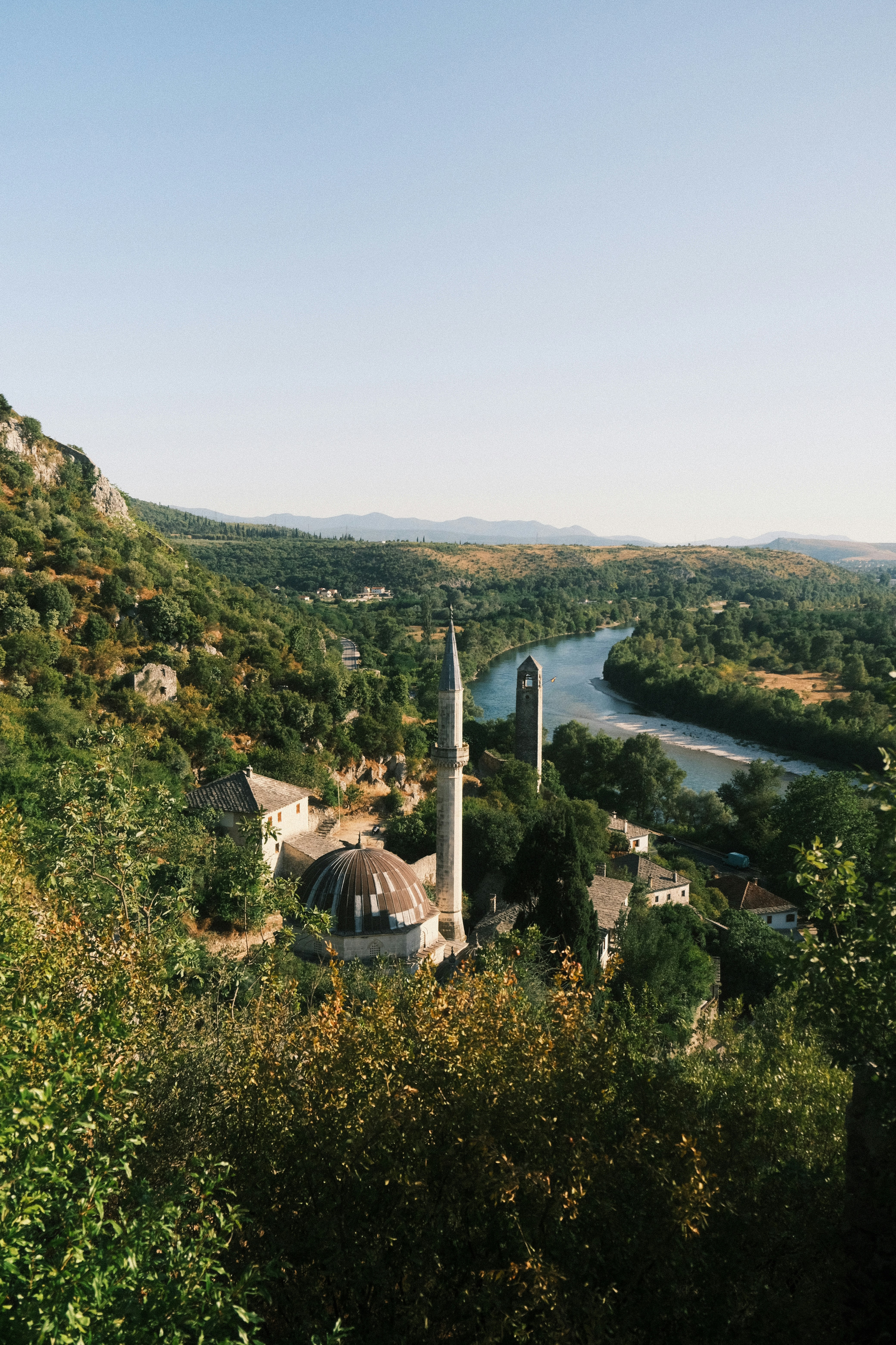 Riverside Mosque and Distant Hills: A Lush Valley Corridor