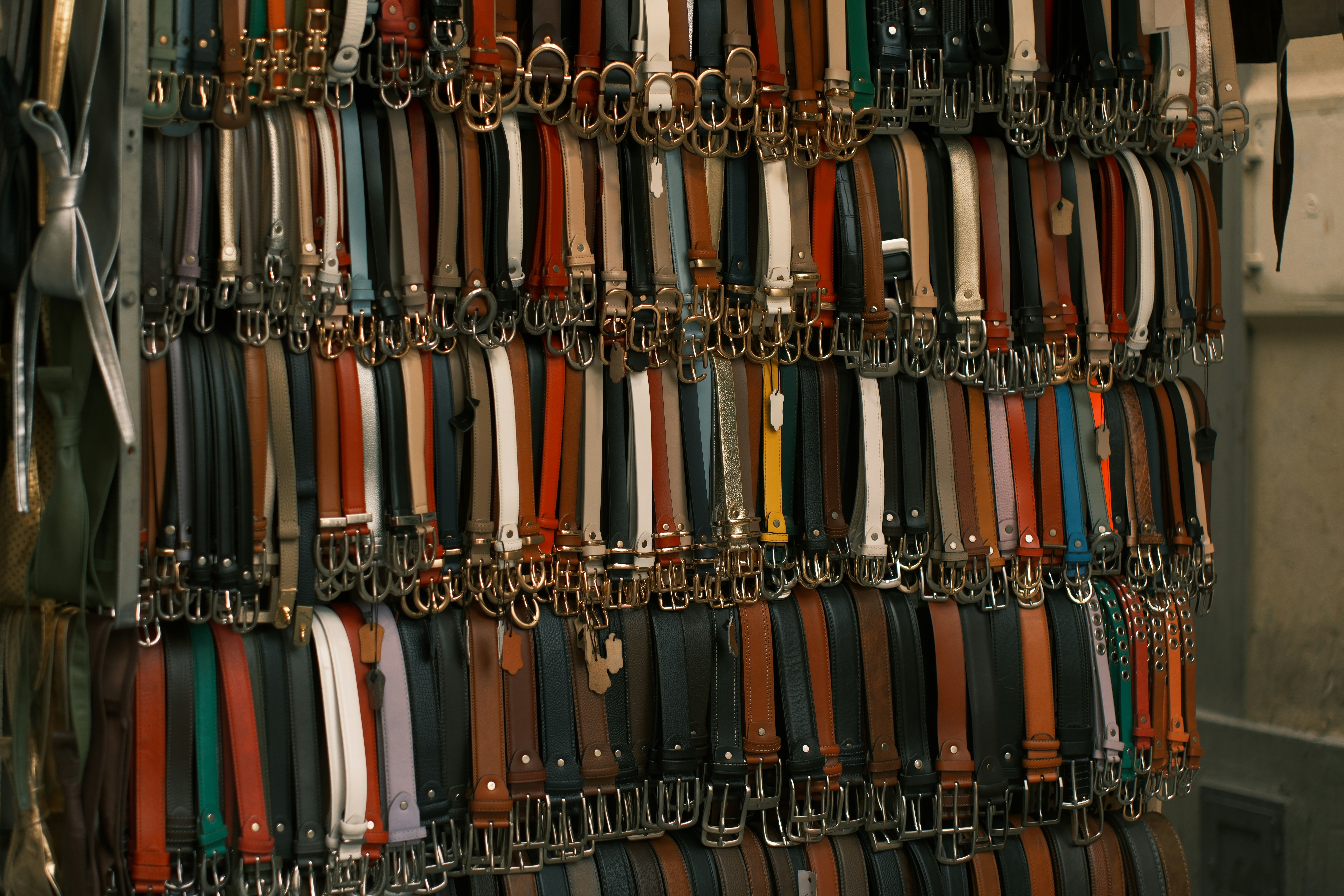 Tapestry of Leather Straps: A Sidewalk Gallery of Colorful Belts