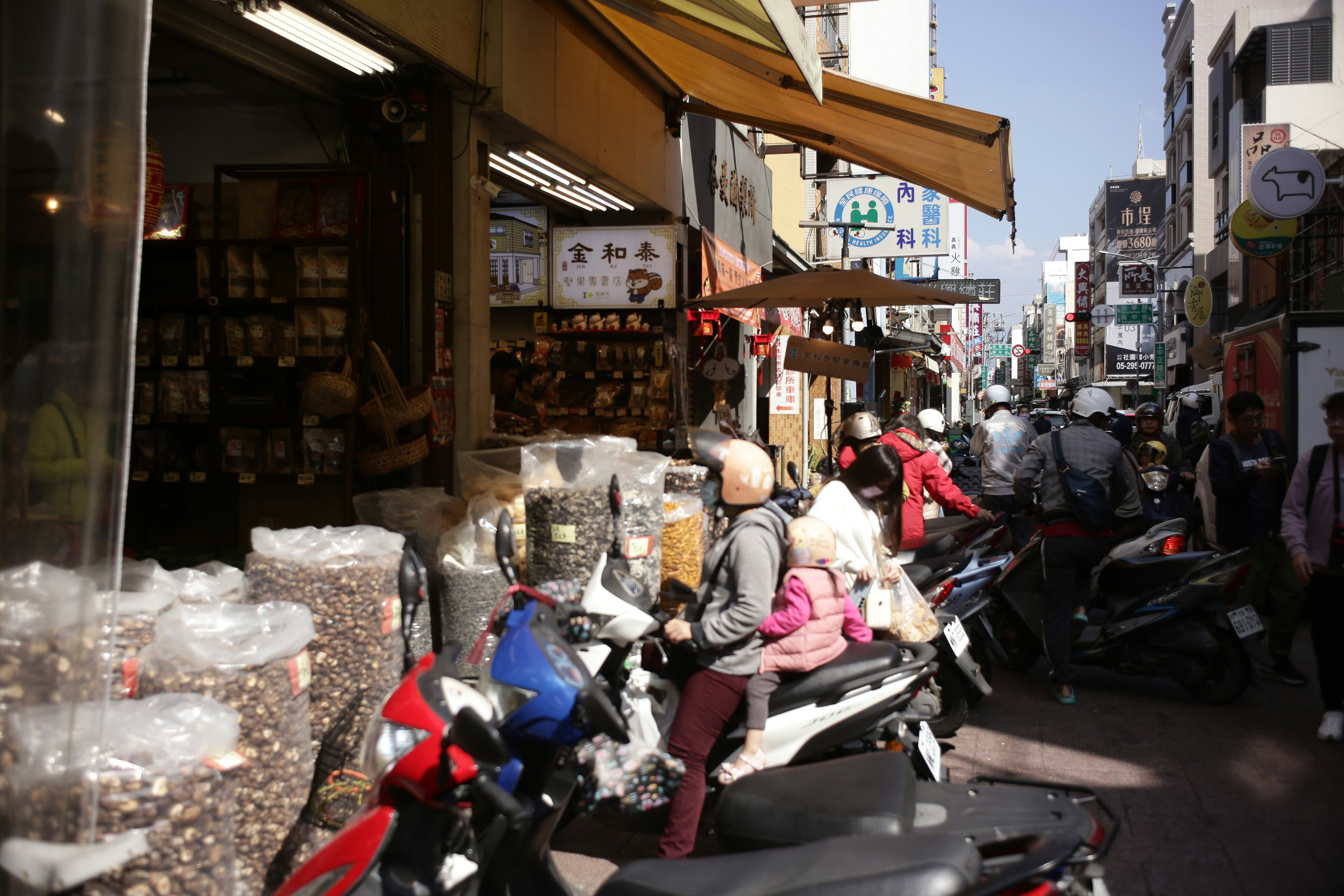 Bustling Market Alley with Scooters and Vendors