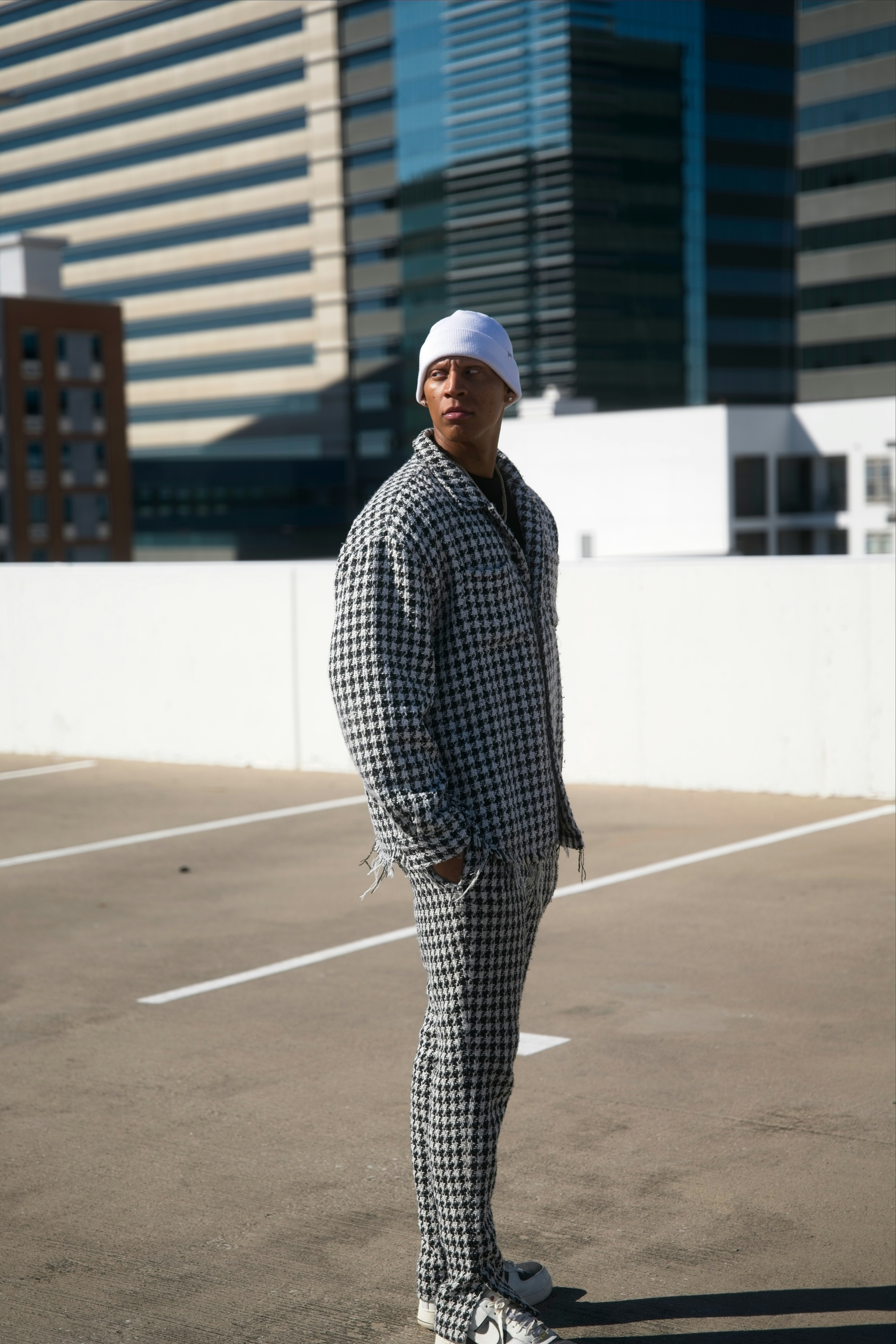 City Edge Style: A solitary figure in a checkered coat on a rooftop