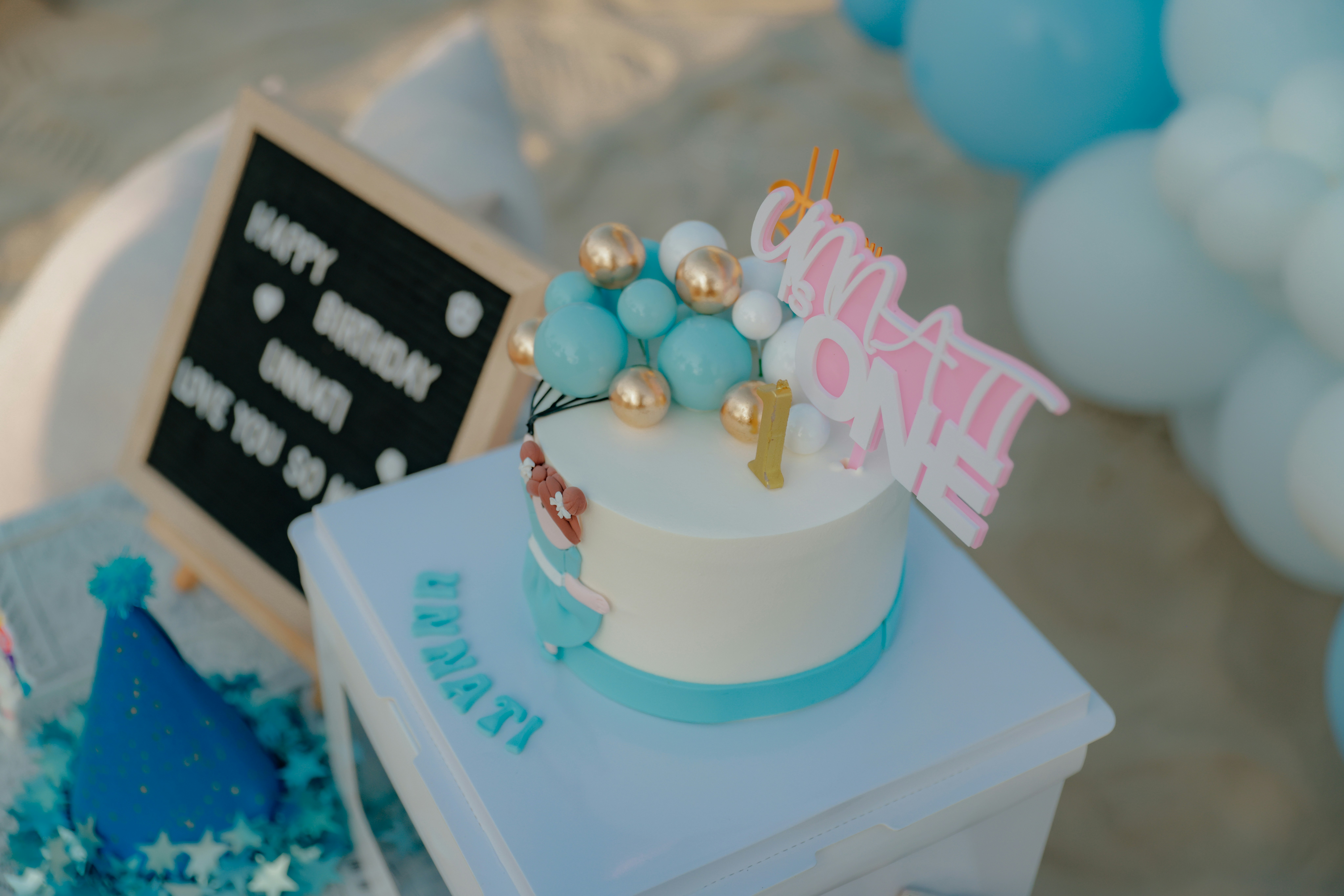 Ice-blue celebration: a balloon-topped cake glows at the party